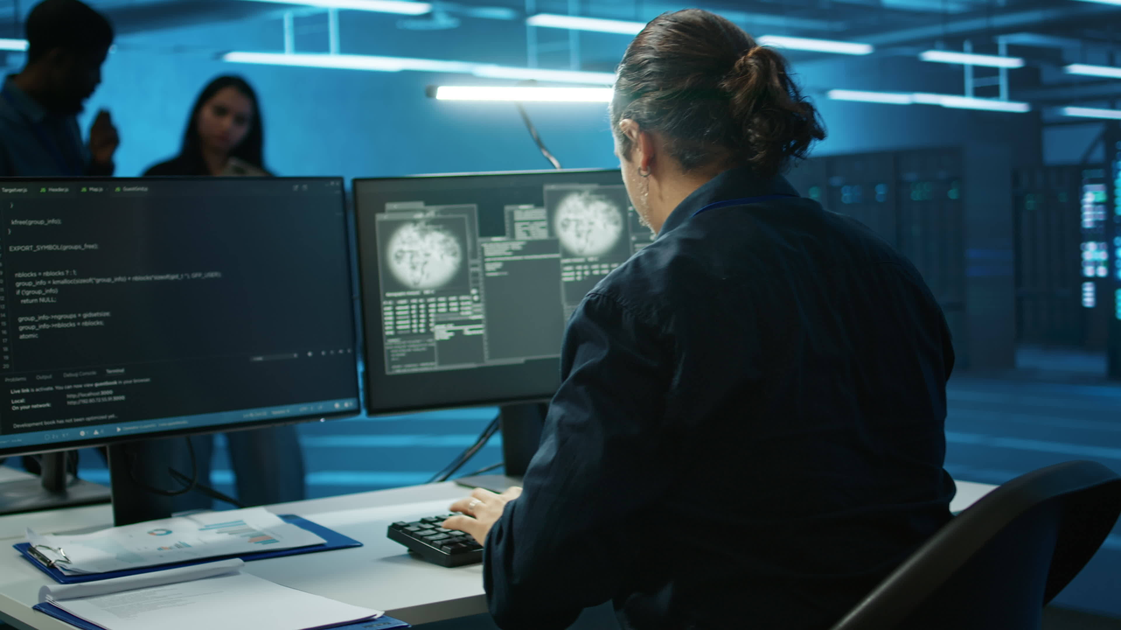 Multiethnic Programmer Team In Server Farm Workspace Surprised By Data