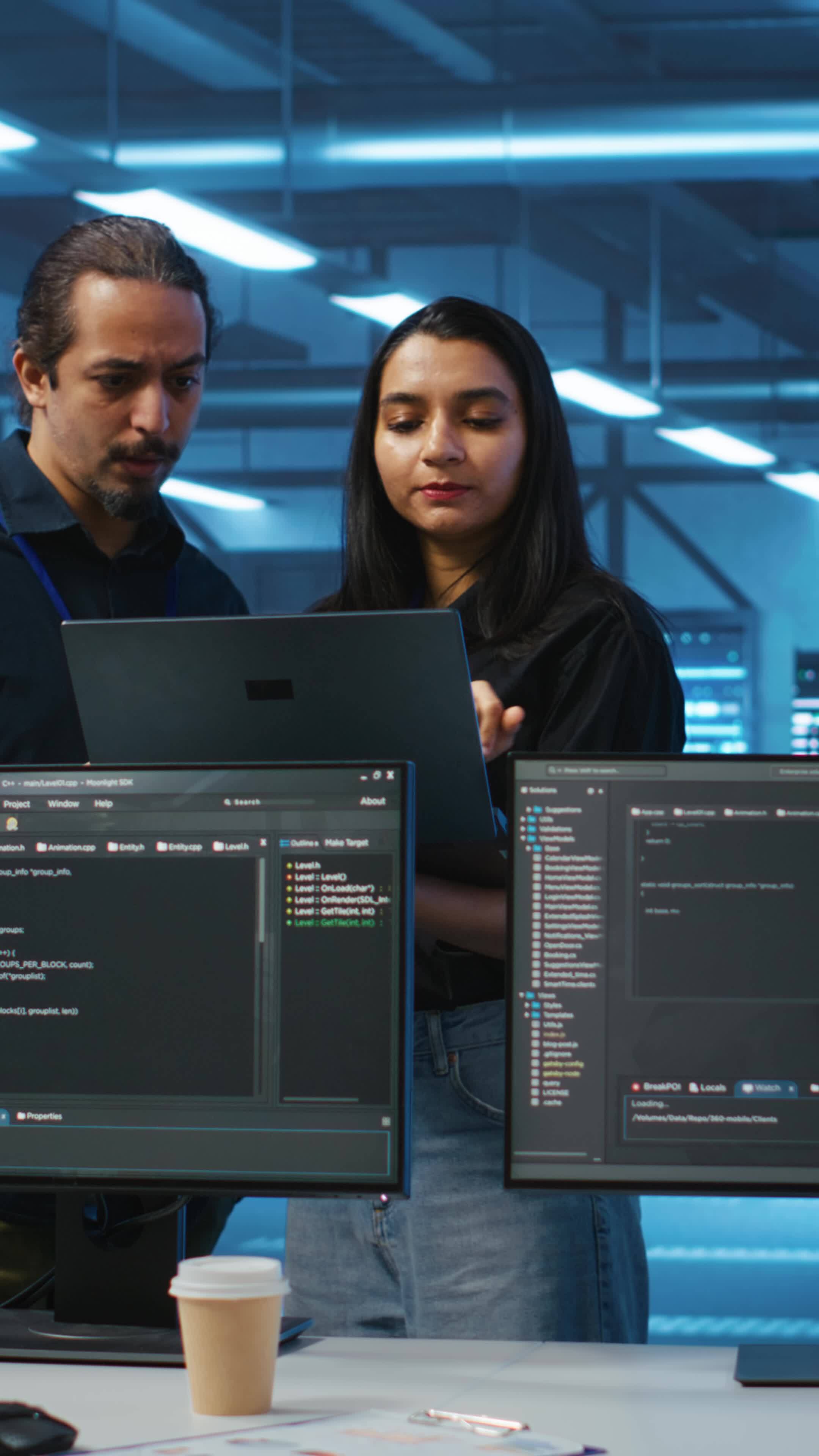 Vertical Multiethnic Team Of Admins Working In High Tech Server Room