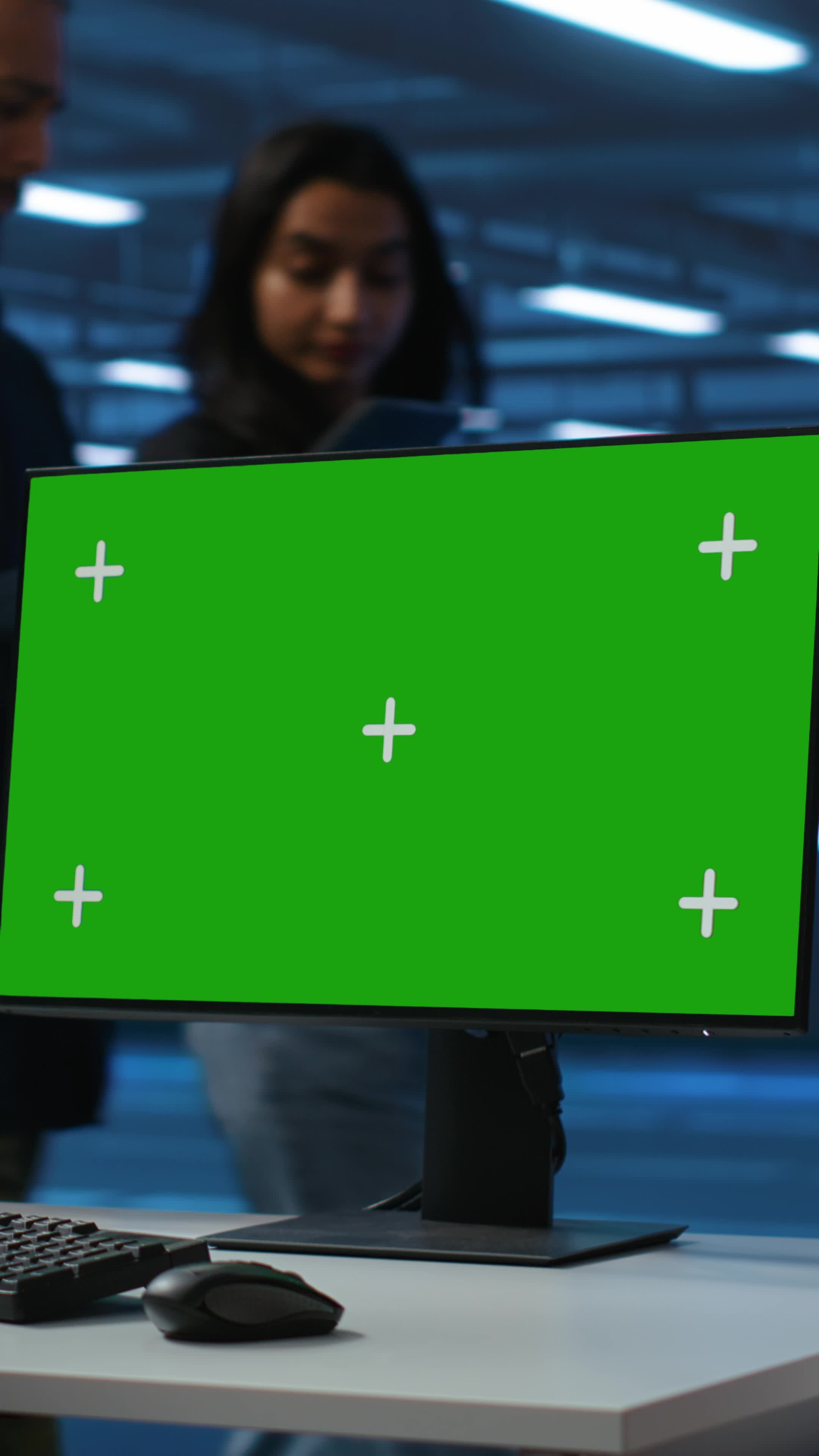 Vertical IT technician looking at green screen PC, working in data ...