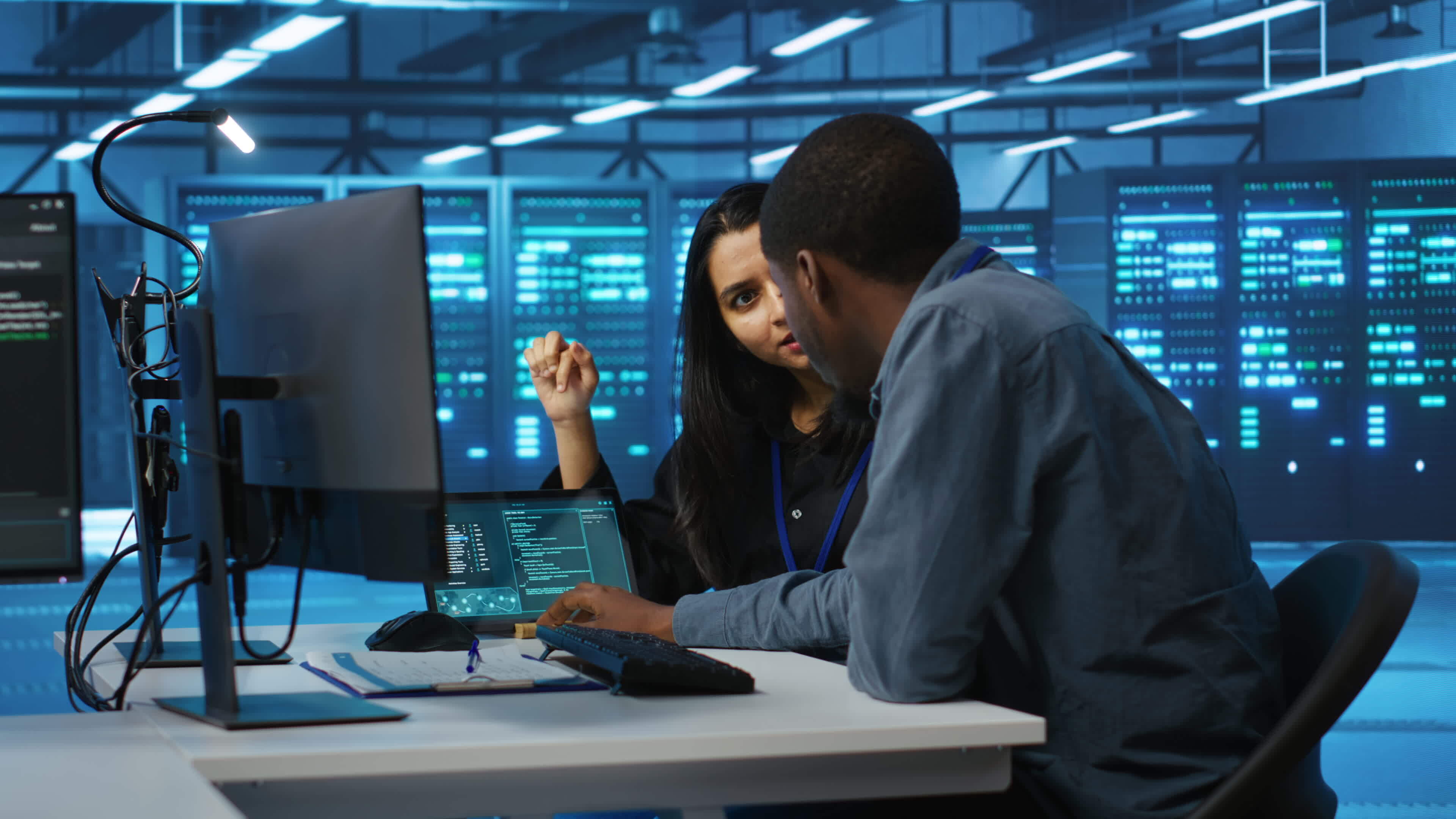 Multiethnic Coworkers Doing System Analysis Of Server Farm