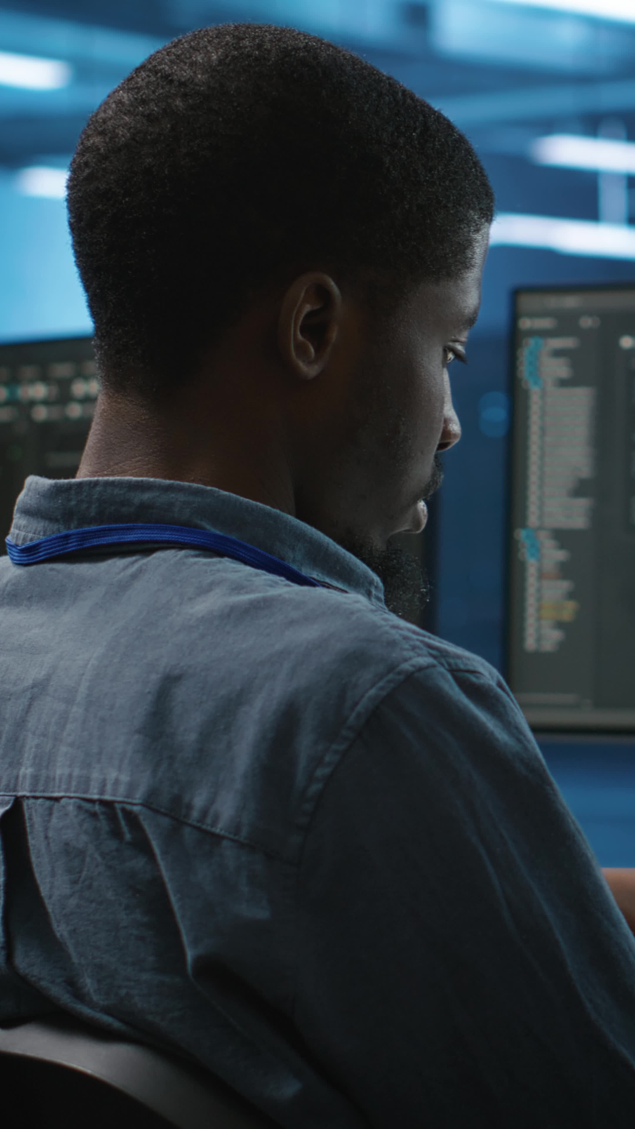 Vertical IT specialist in server farm ensuring valuable data remains shielded from potential ...