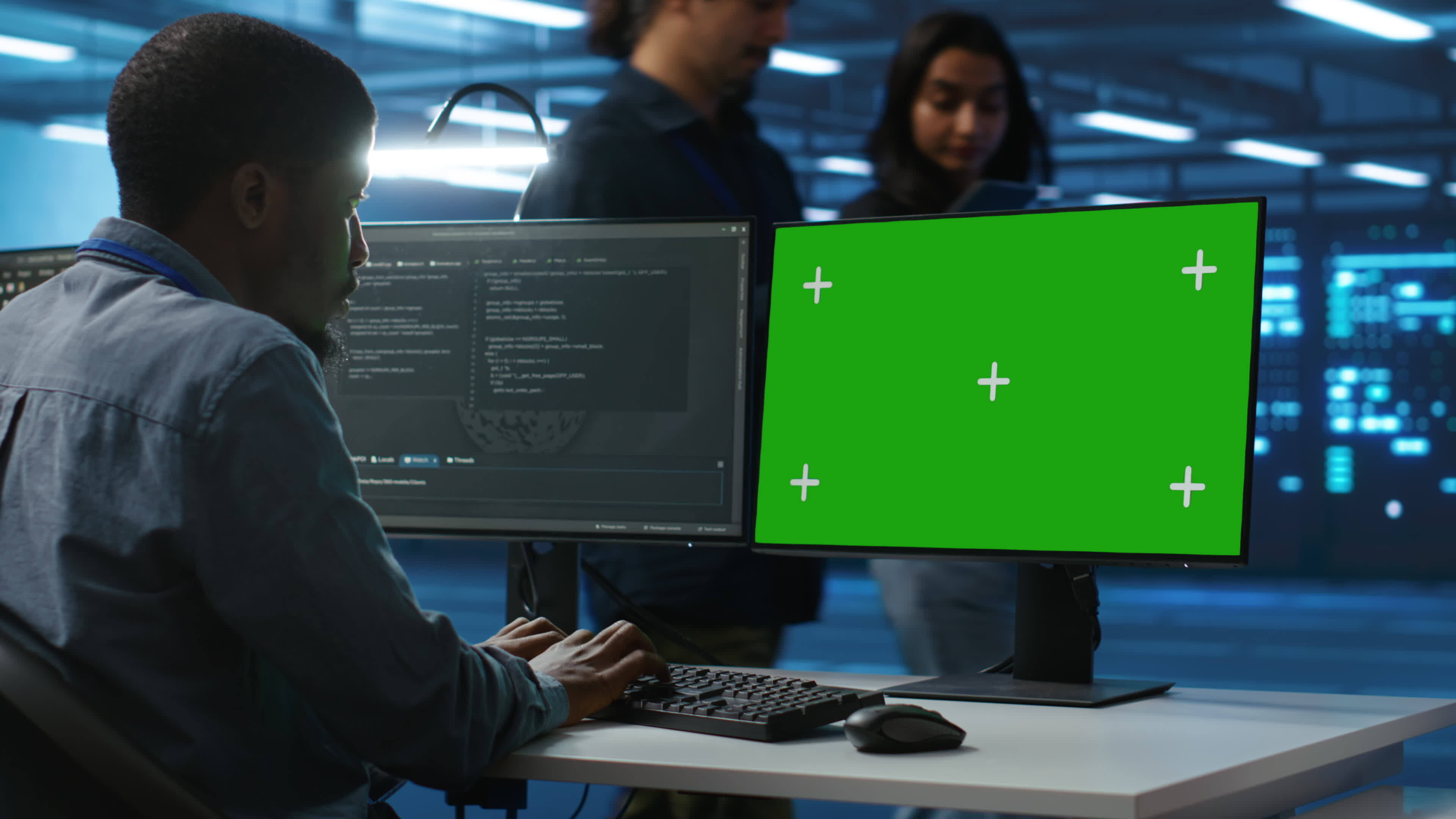 It Technician Looking At Green Screen Pc Working In Data Center