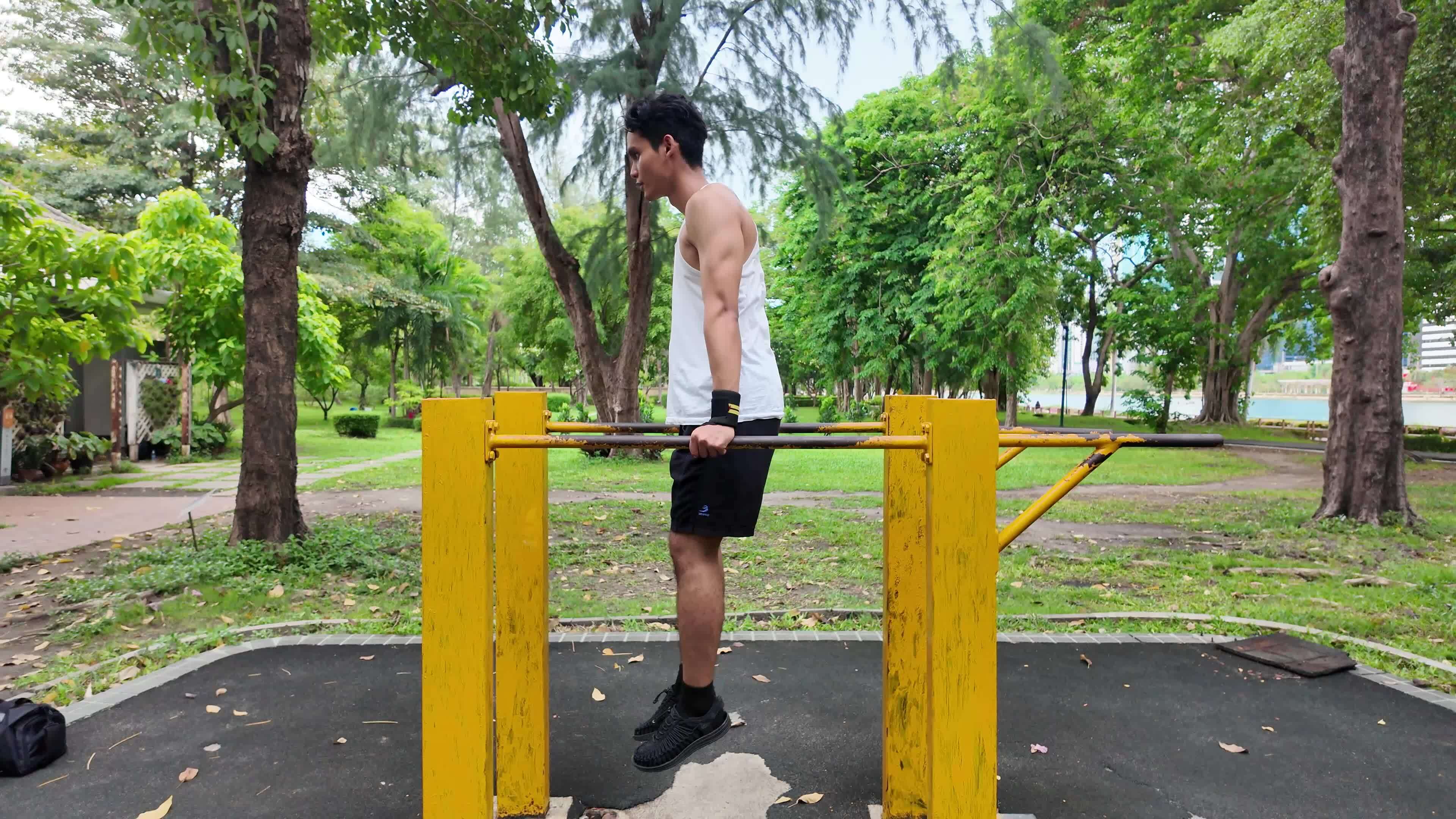 Asian Man Practicing Gymnastics Doing Gymnastics Bar And Hoop Exercises And Stretching And