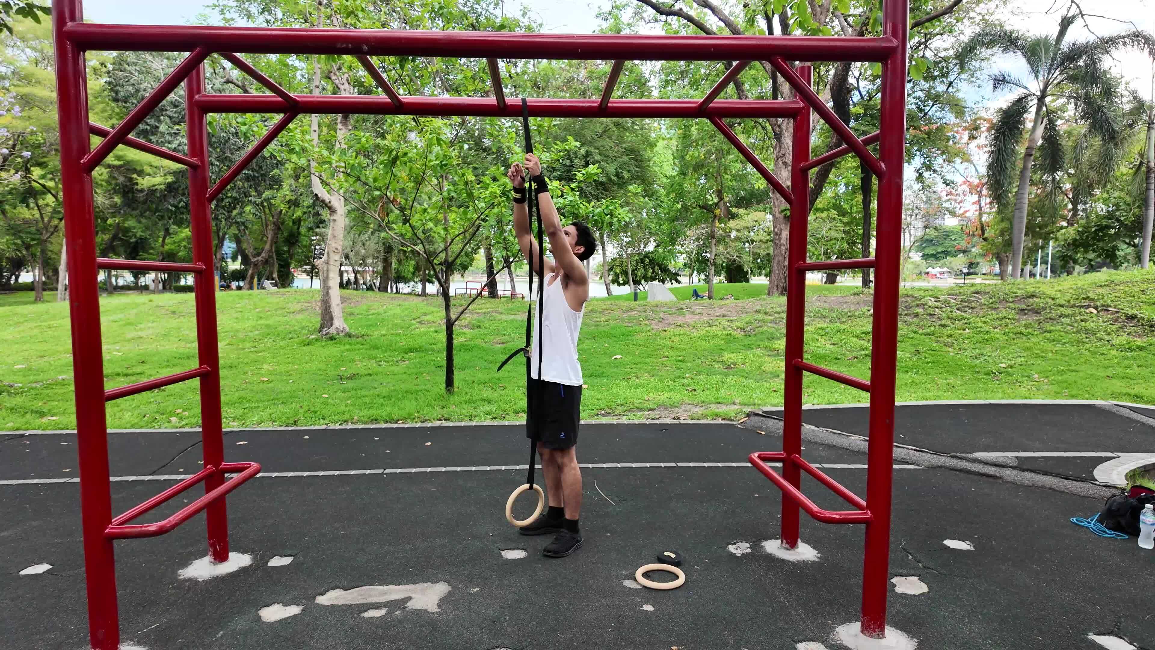 Asian Man Practicing Gymnastics Doing Gymnastics Bar And Hoop Exercises And Stretching And