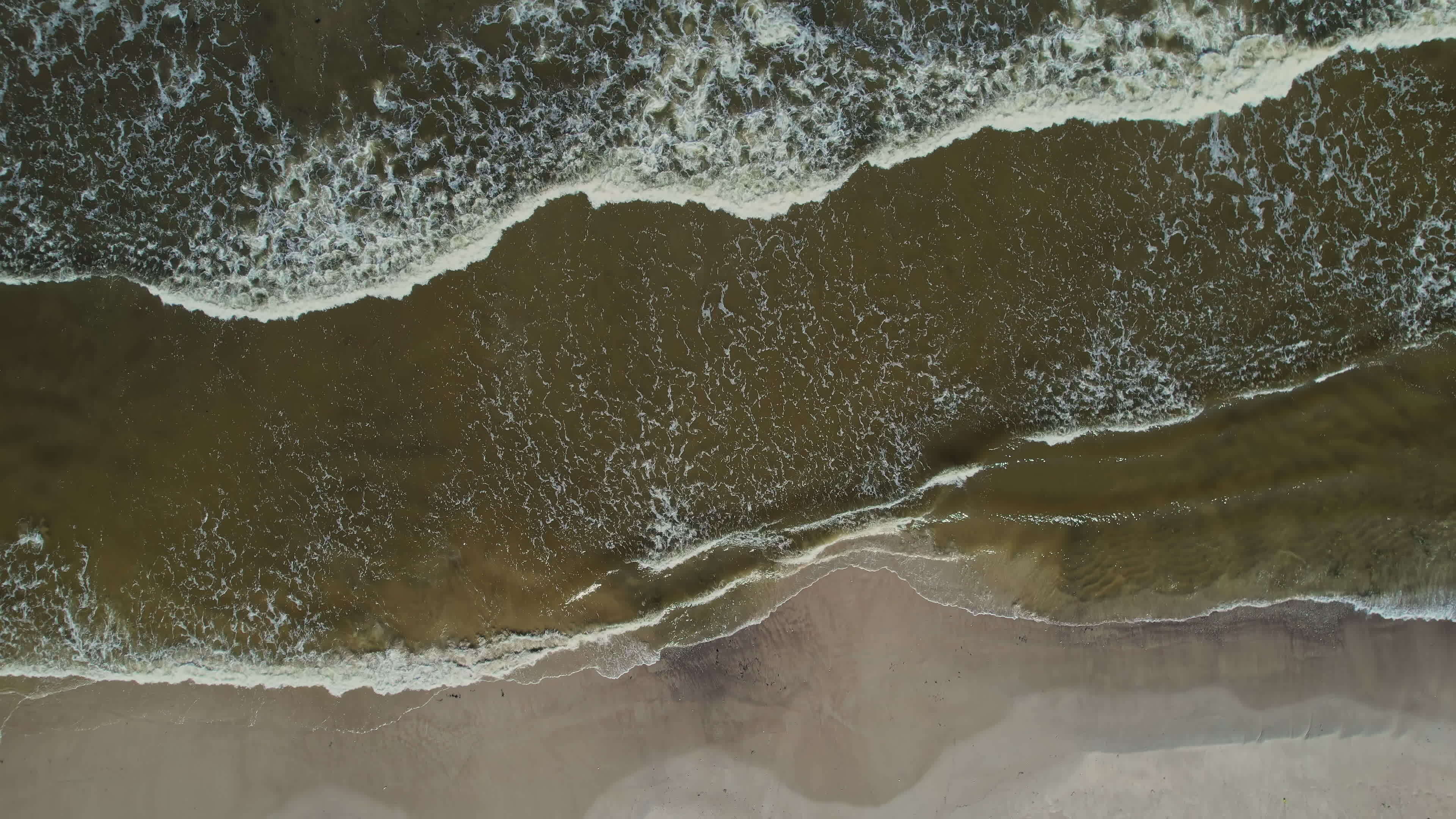 An aerial view of a sandy beach with waves 46136137 Stock Video at Vecteezy