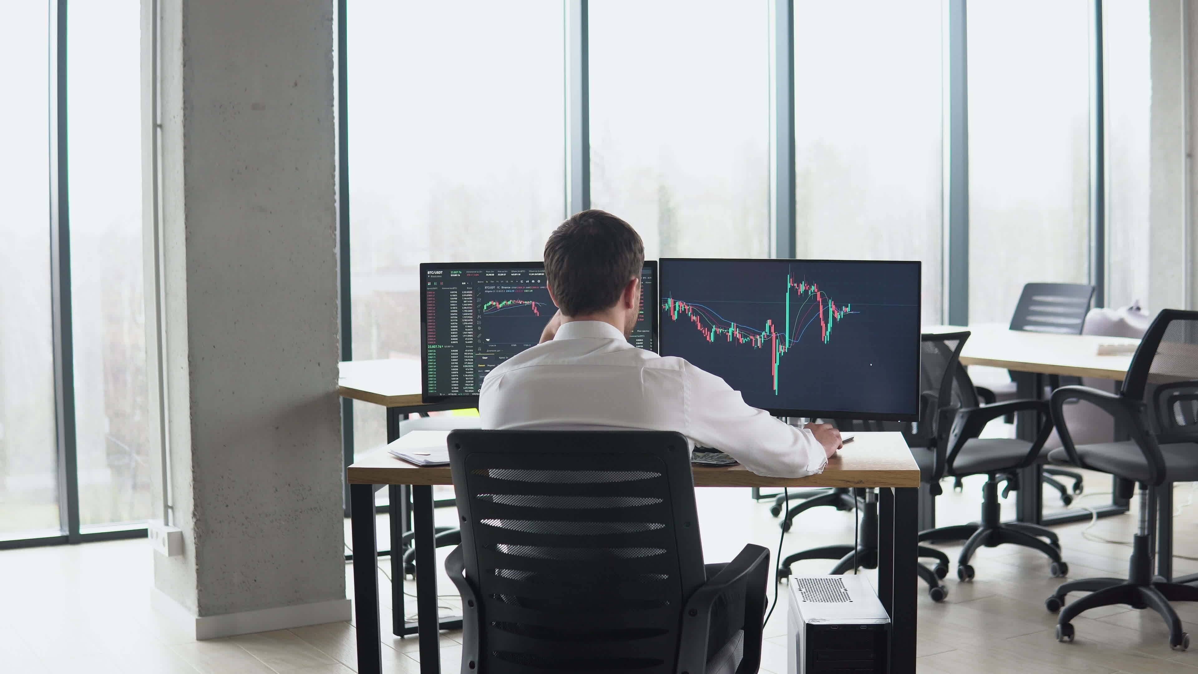 Back View Of Trader Is Working With Multiple Computer Screens Full Of
