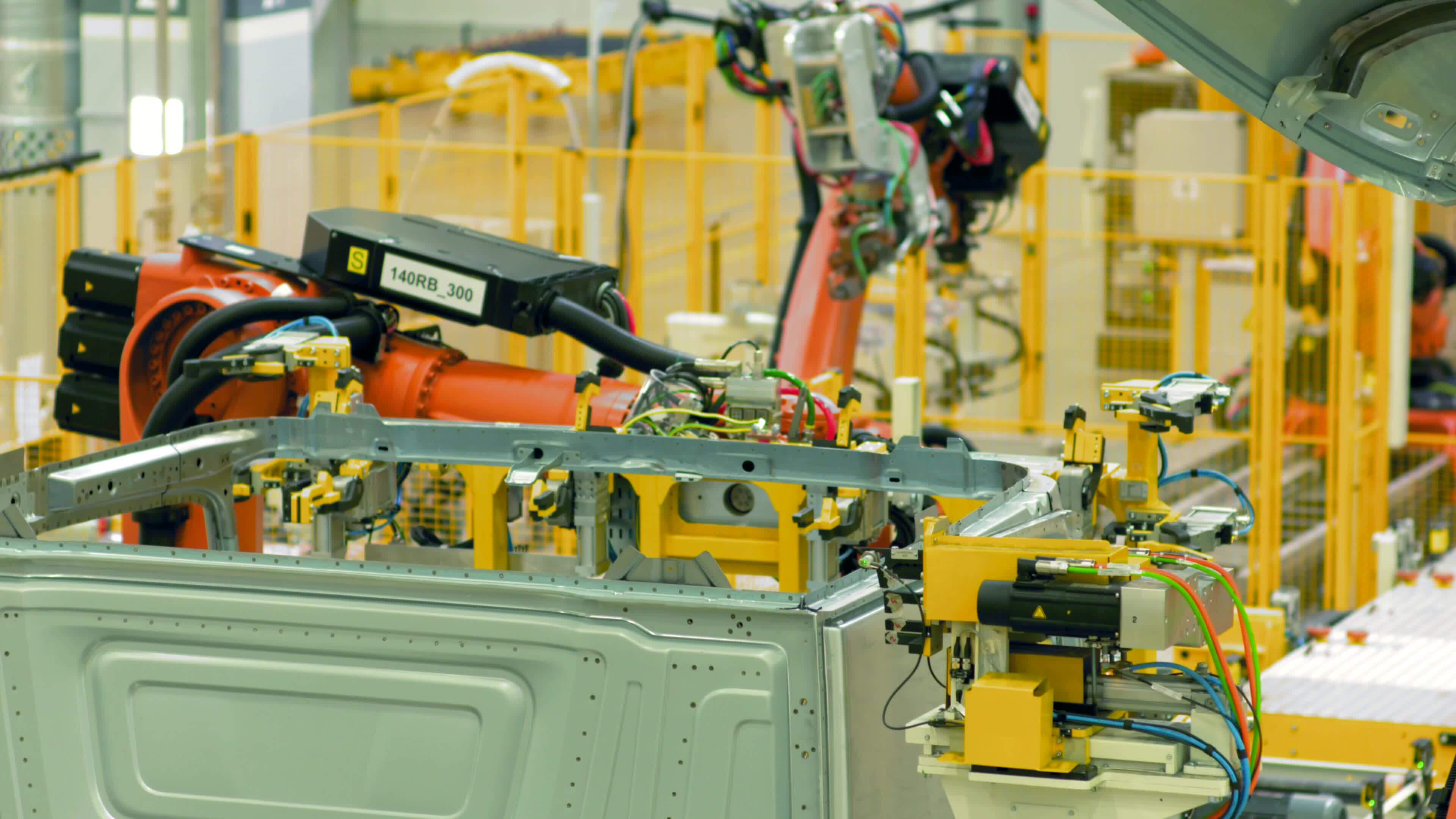 Automated car assembly at factory. Scene. Automated machines assemble ...