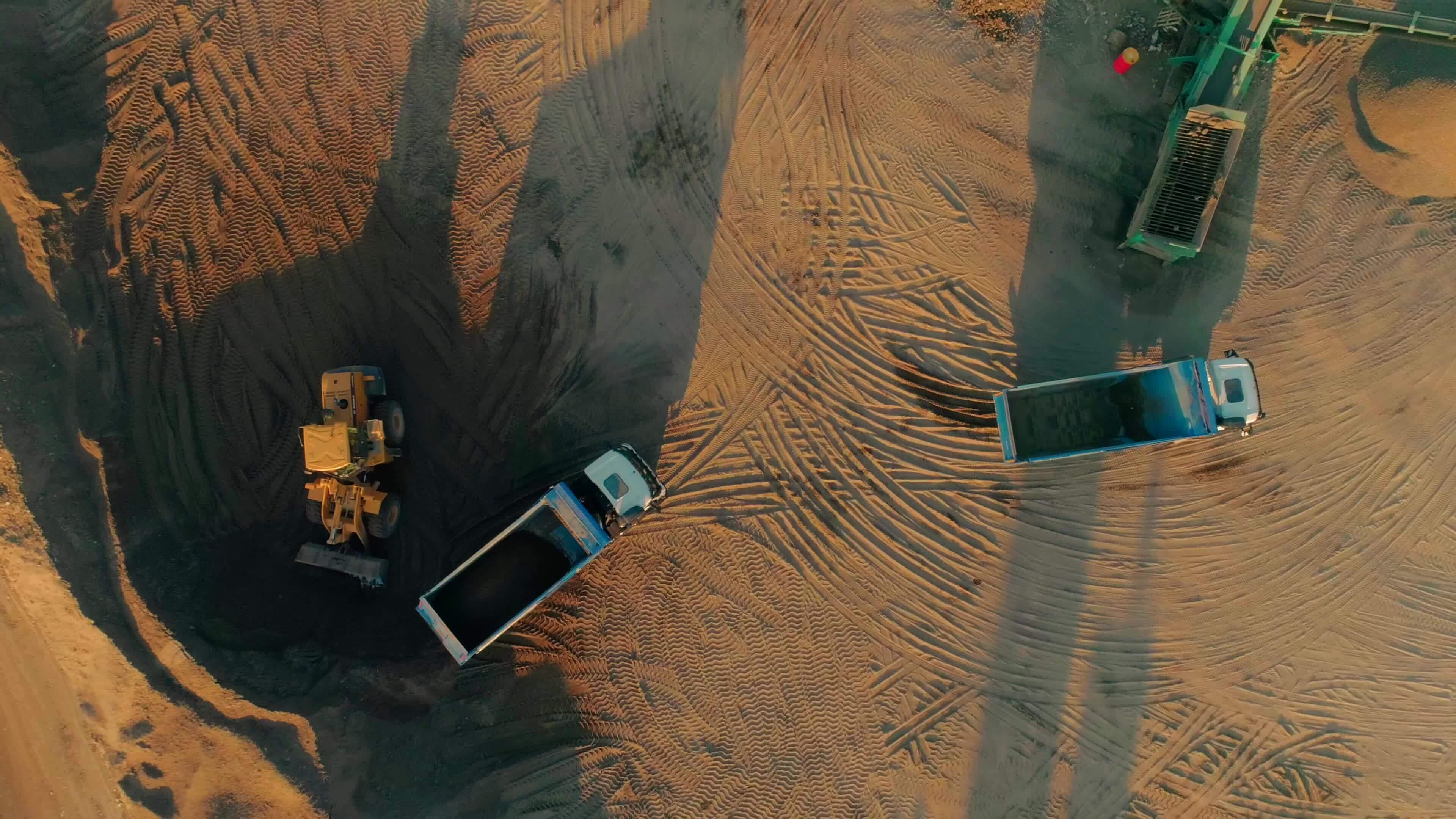 The construction process . The view from the drone. Scene . Huge lorry build and load cargo for ...