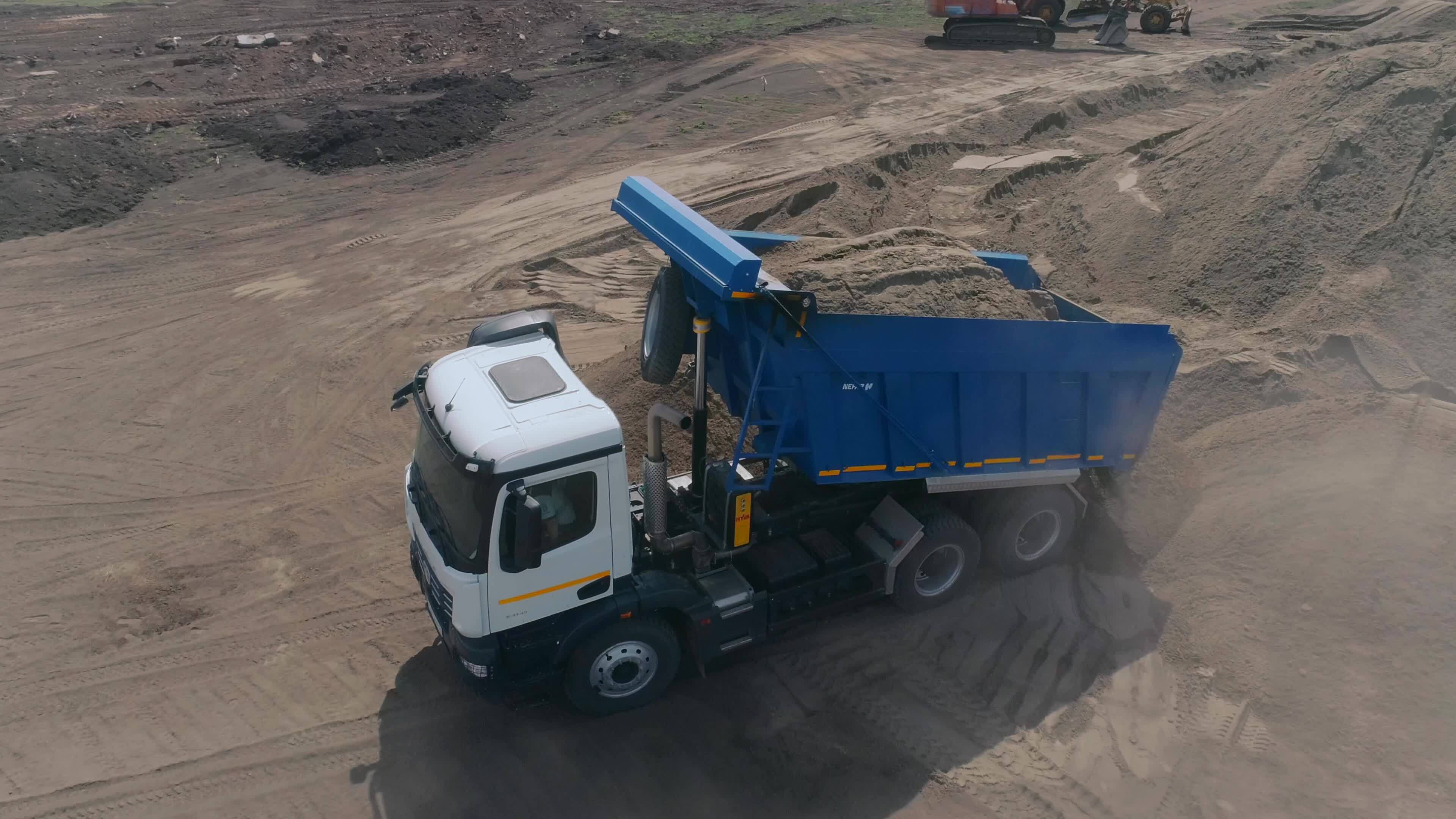 The construction process . The view from the drone. Scene . Huge lorry build and load cargo for ...
