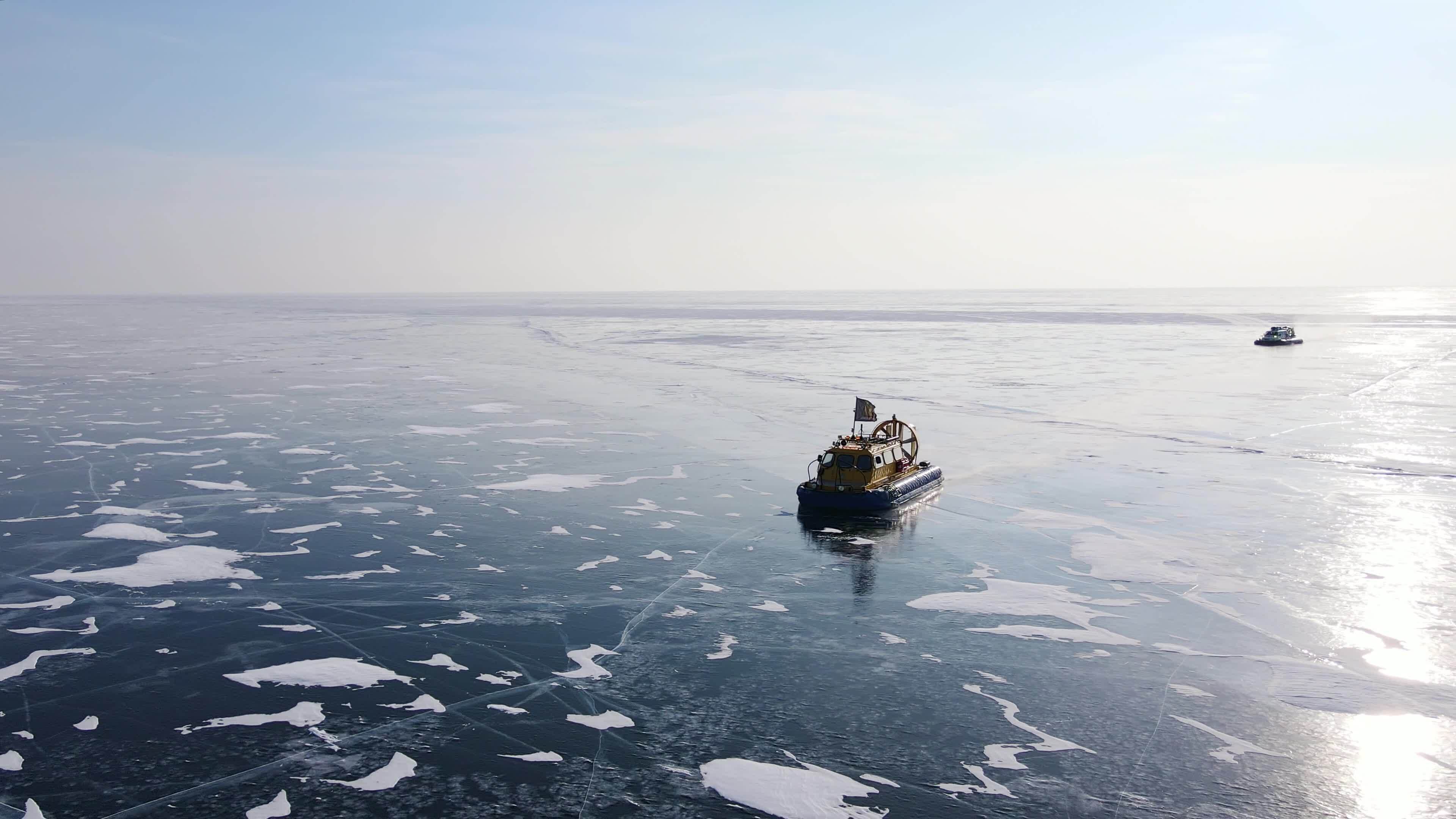 An icebreaker ship navigating through frozen sea ice in winter, seen ... An icebreaker ship navigating through frozen sea ice in winter, seen ...