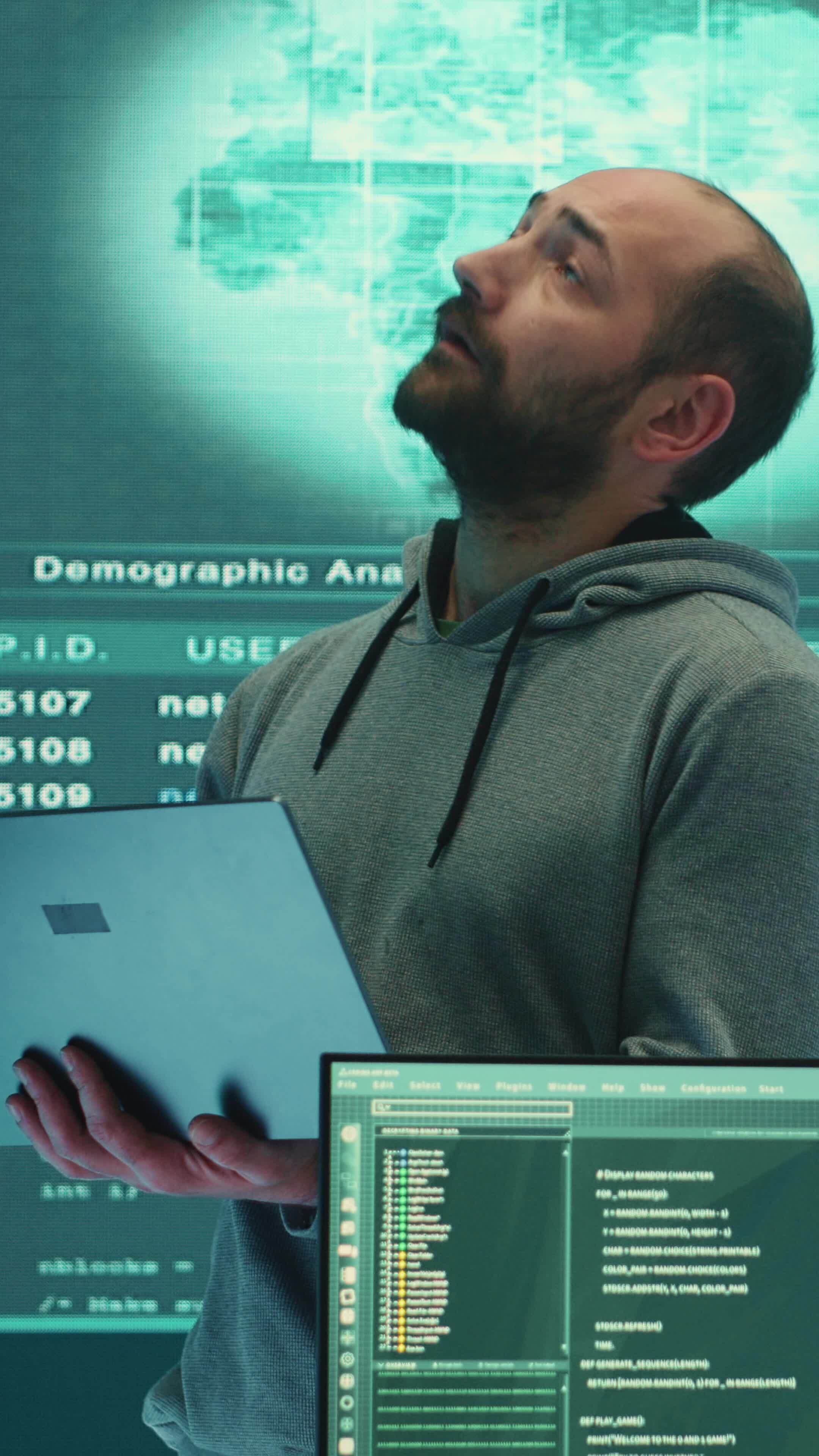 Vertical Governmental Hacker Examines Info On A Big Screen In Agency Office Using Advanced