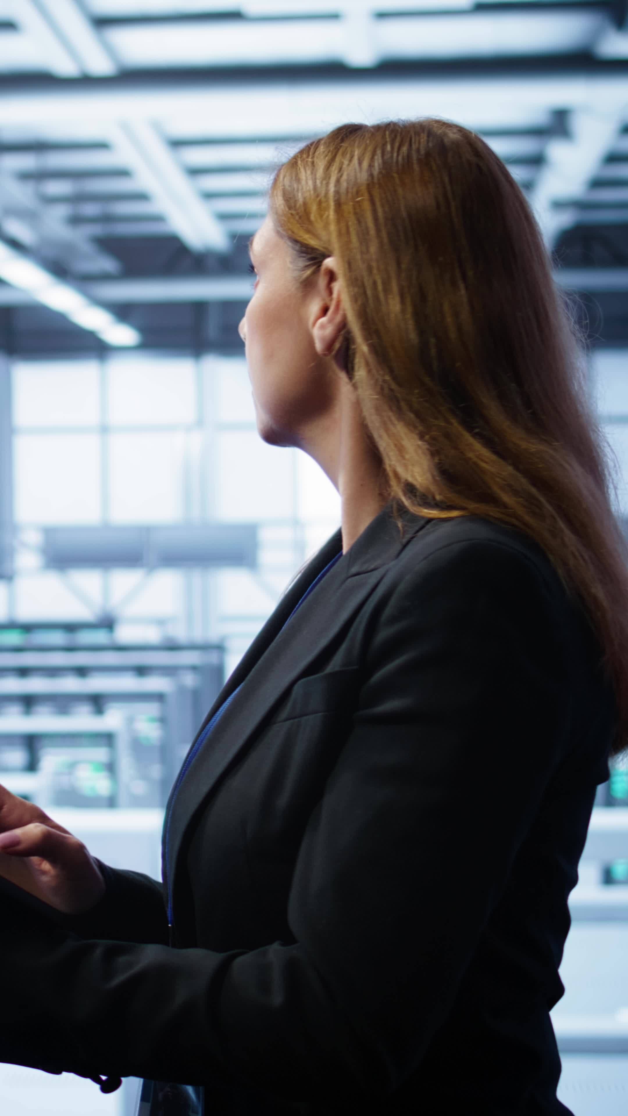 Vertical Computer Scientist Doing Checkup Inputting Data On Tablet Of Needed Fixes In Server