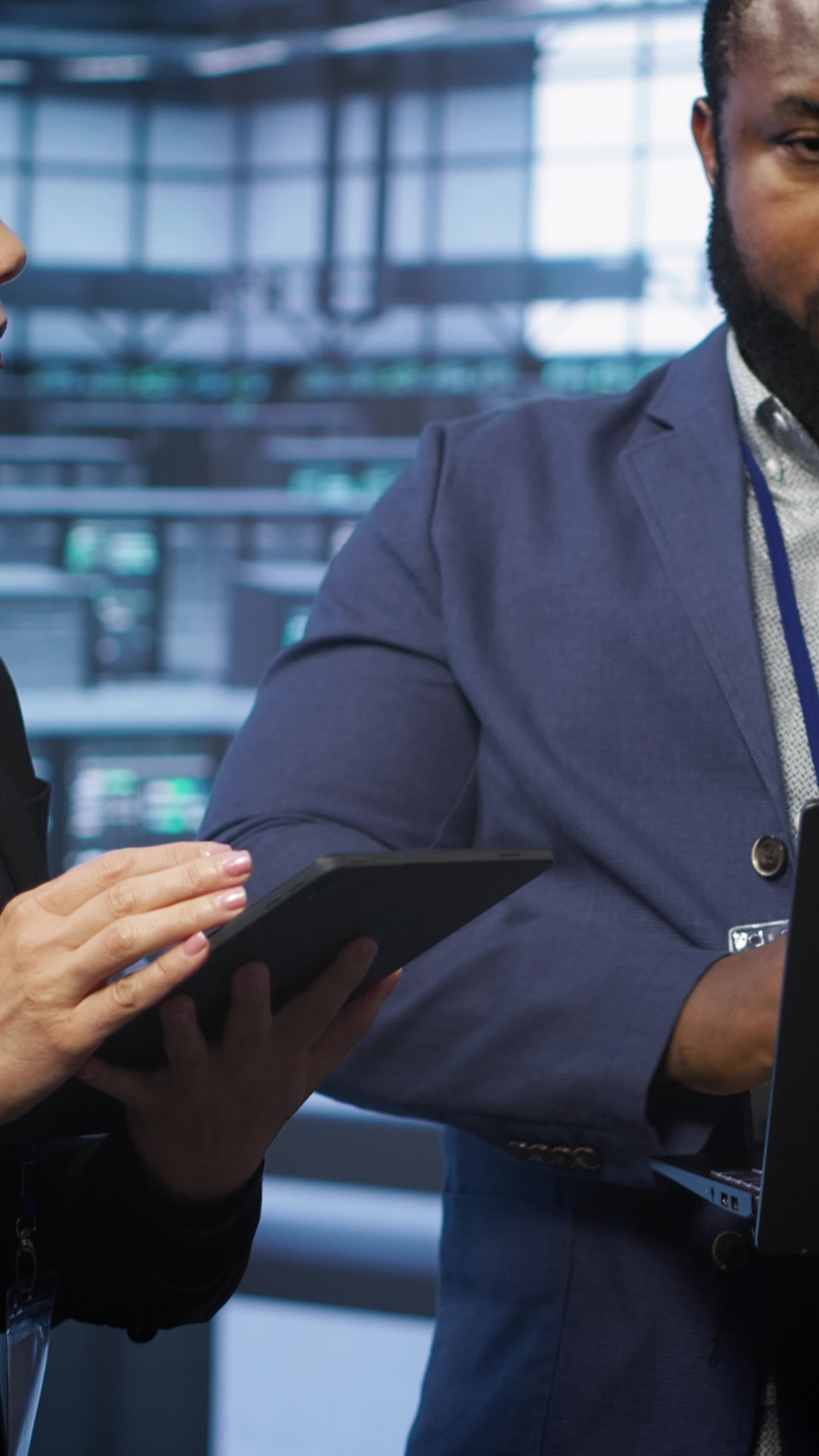 Vertical Teamworking technicians managing data center with advanced ... Vertical Teamworking technicians managing data center with advanced ...