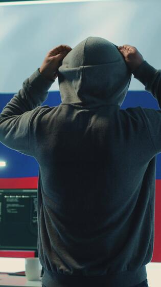 Vertical Russian Hacker With A Hood Installing Panic By Misconception