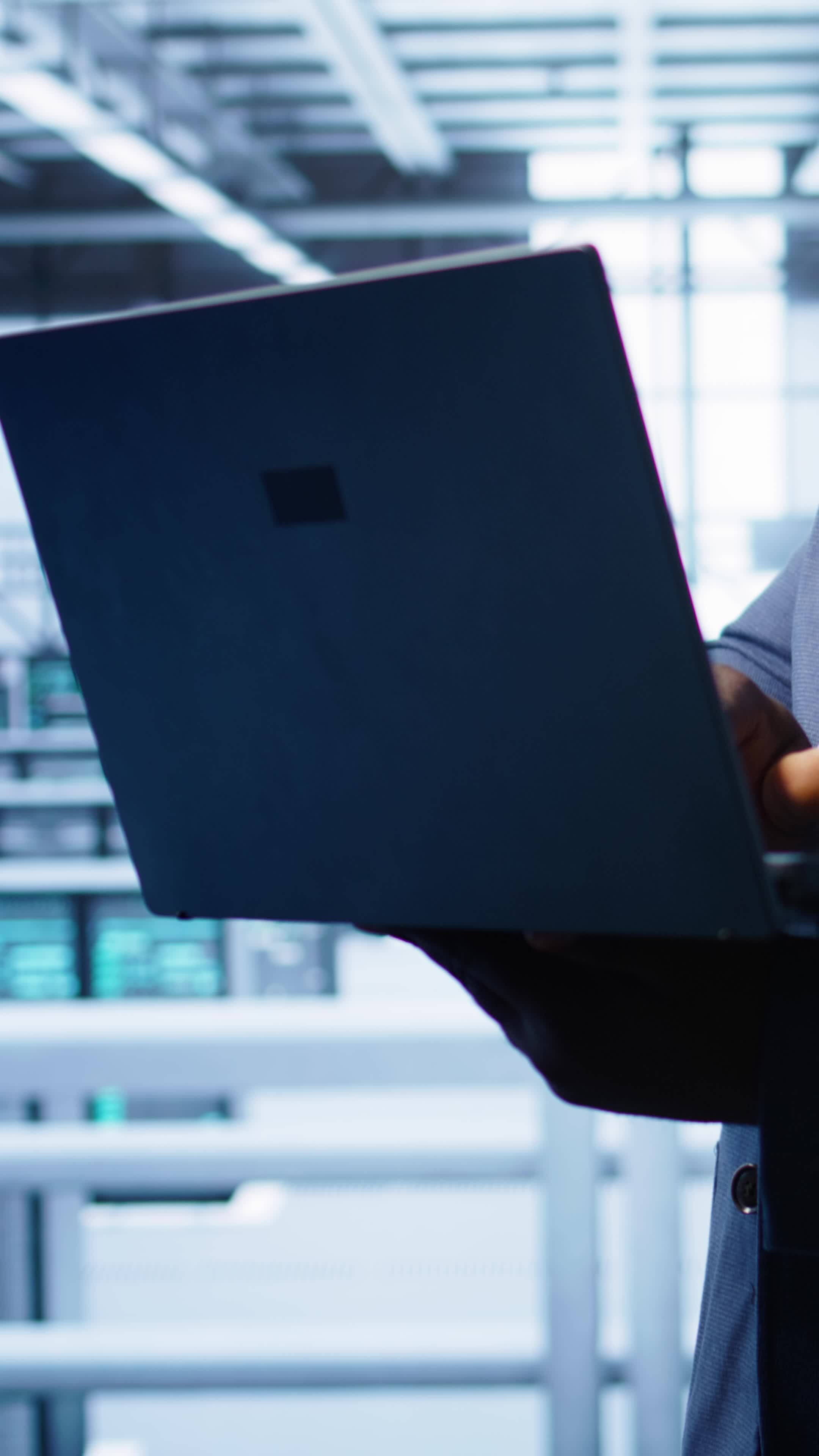 Vertical Computer Scientist In High Tech Facility Using Laptop To Patch