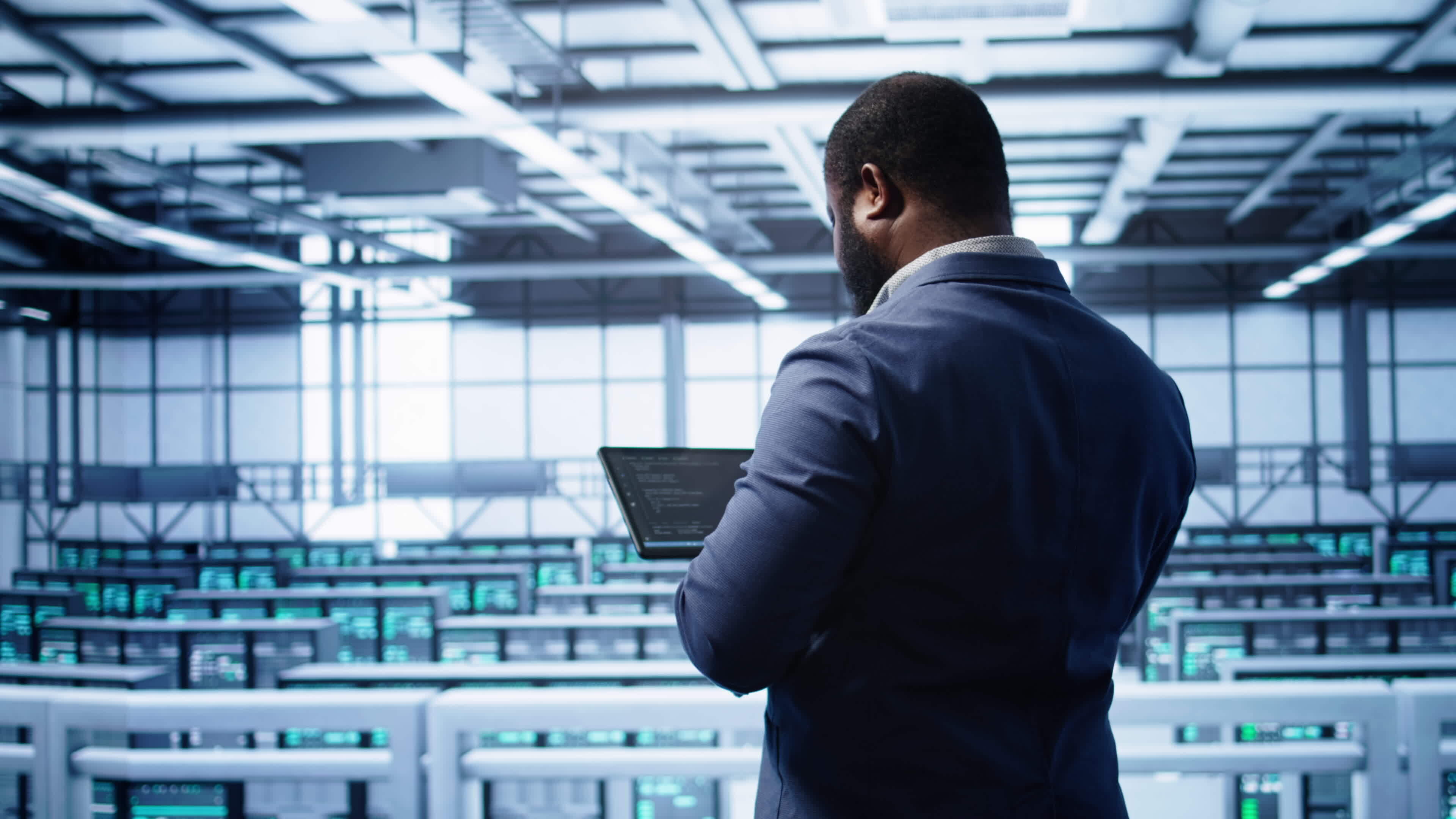 It Operator In Server Room Workspace Using Tablet To Patch Network Issues Affecting Transfer