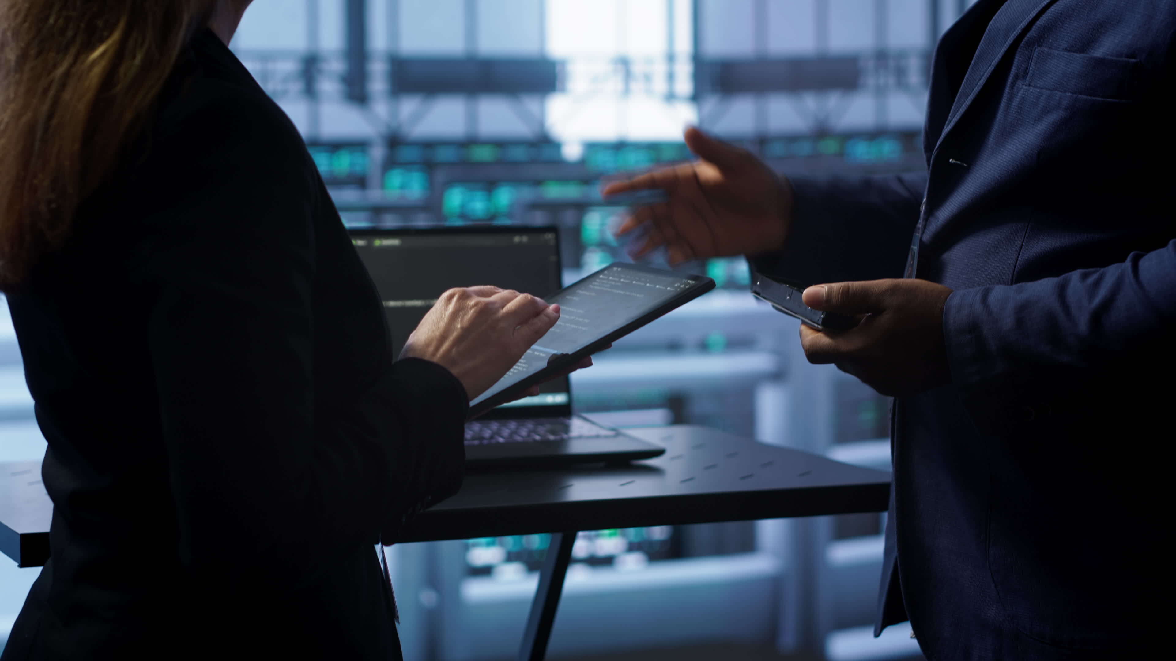 Team of admins in server room location installing newly ordered storage unit, close up ...