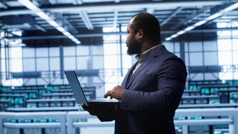 Computer Scientist In Server Hub Checking Recovery Plan On Laptop Monitoring Hardware Energy