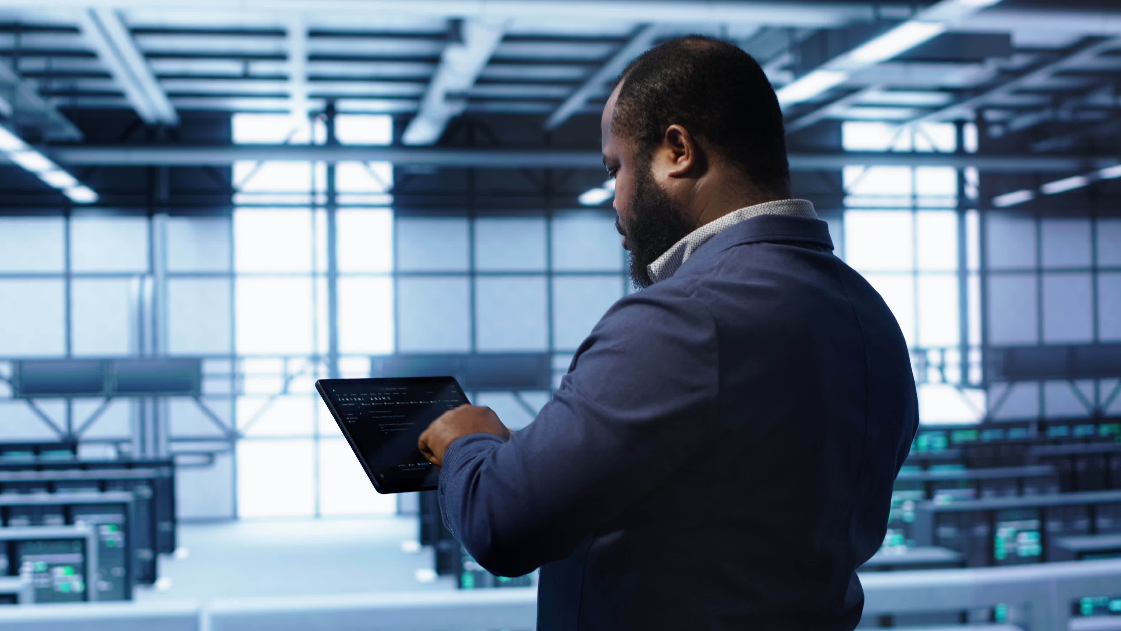 It Operator In Server Room Workspace Using Tablet To Patch Network Issues Affecting Transfer