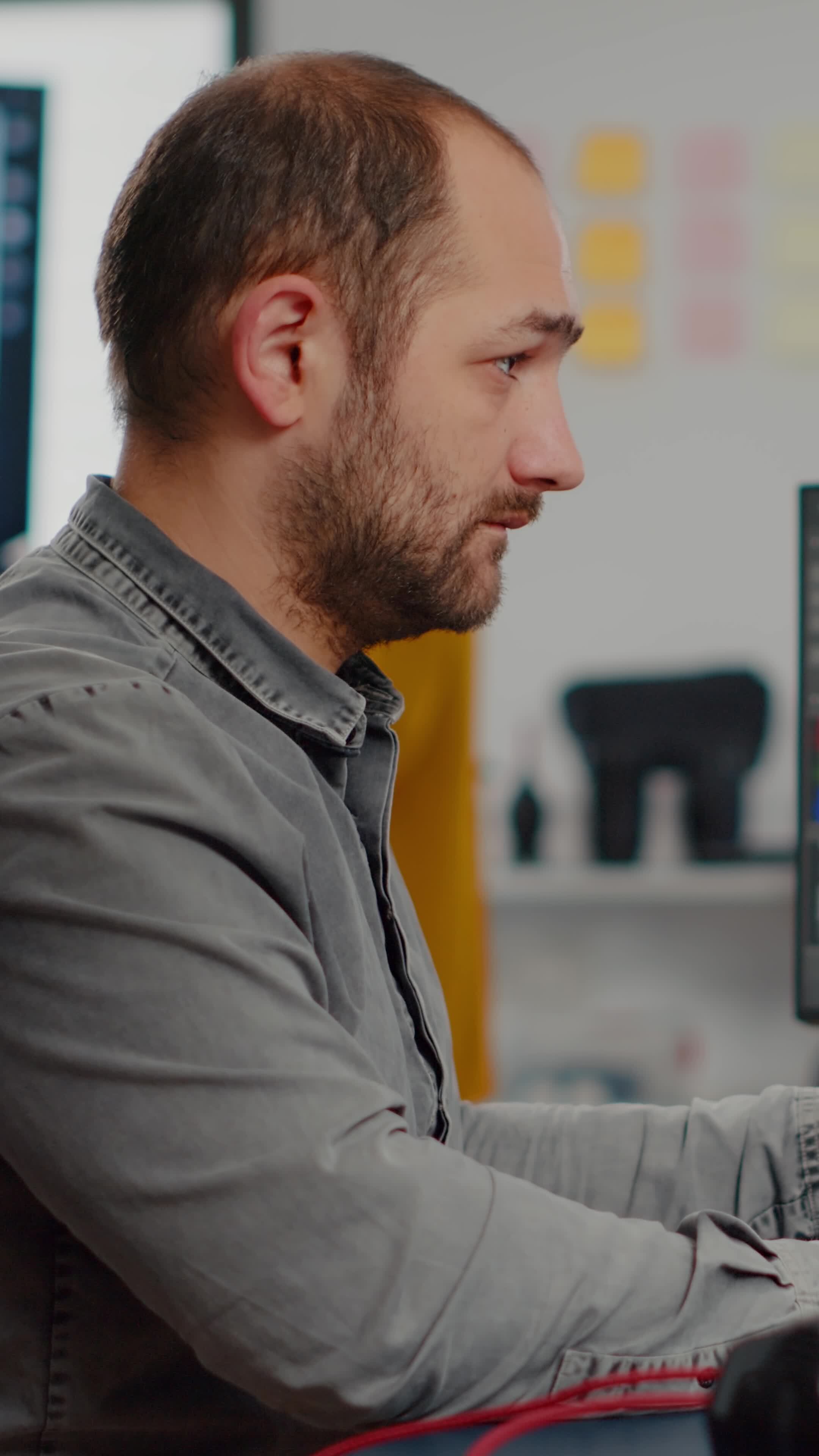 Videographer Looking At Camera Smiling Working In Creative Startup Workplace Using Editing Post