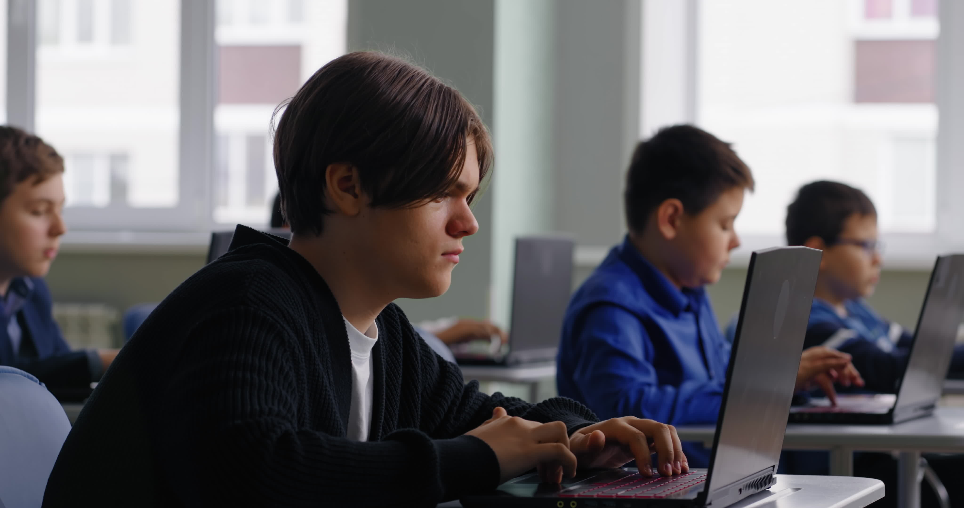 Concentrated Teenager Student Practicing With PC In Computer-Based ...