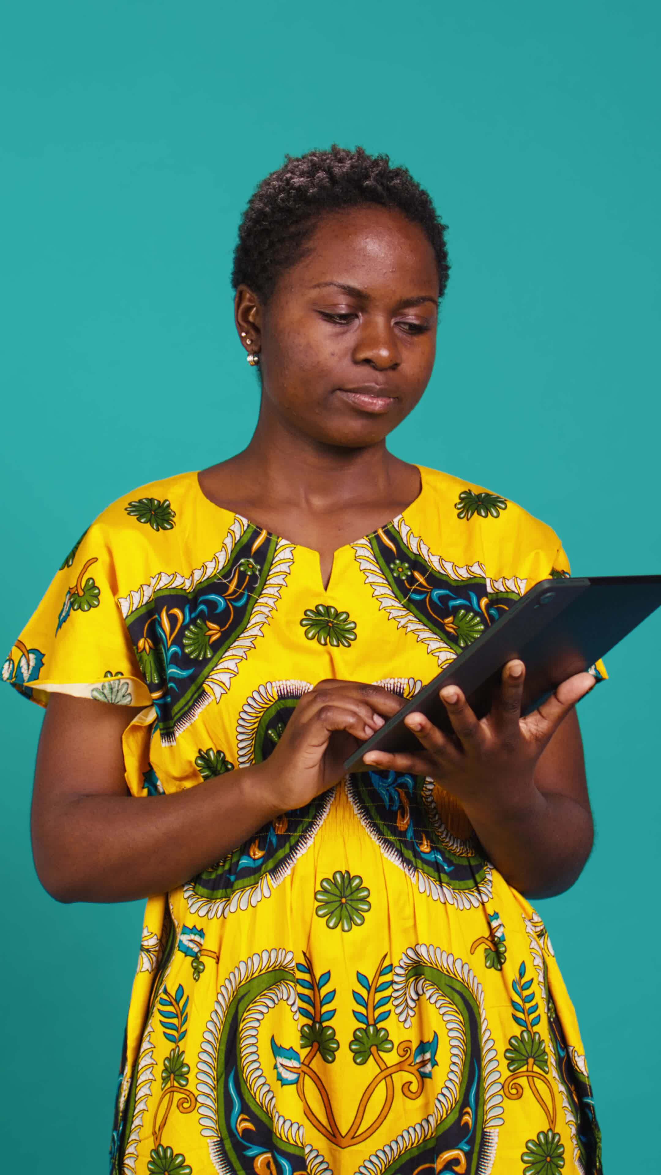 Vertical Natural Cute Girl Browsing Internet On A Tablet Against Blue Background Navigating On