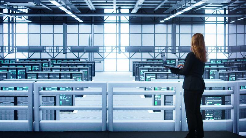 Computer scientist doing maintenance, inputting data on laptop of ...