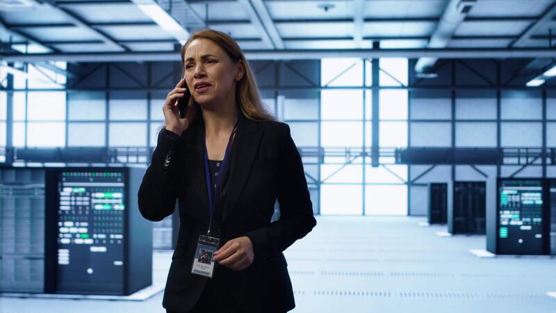 Software Engineer Talking On Smartphone In Data Center Coordinating Server Maintenance Tasks