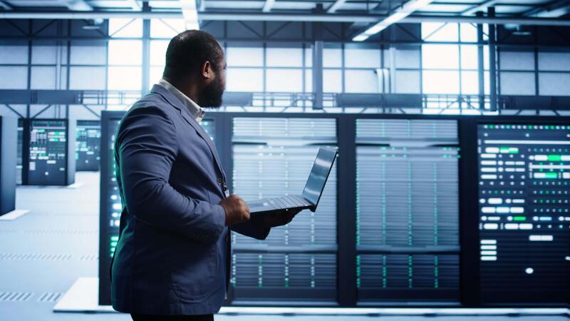Admin Doing Yearly Checkup Using Notebook To Prolong Data Center
