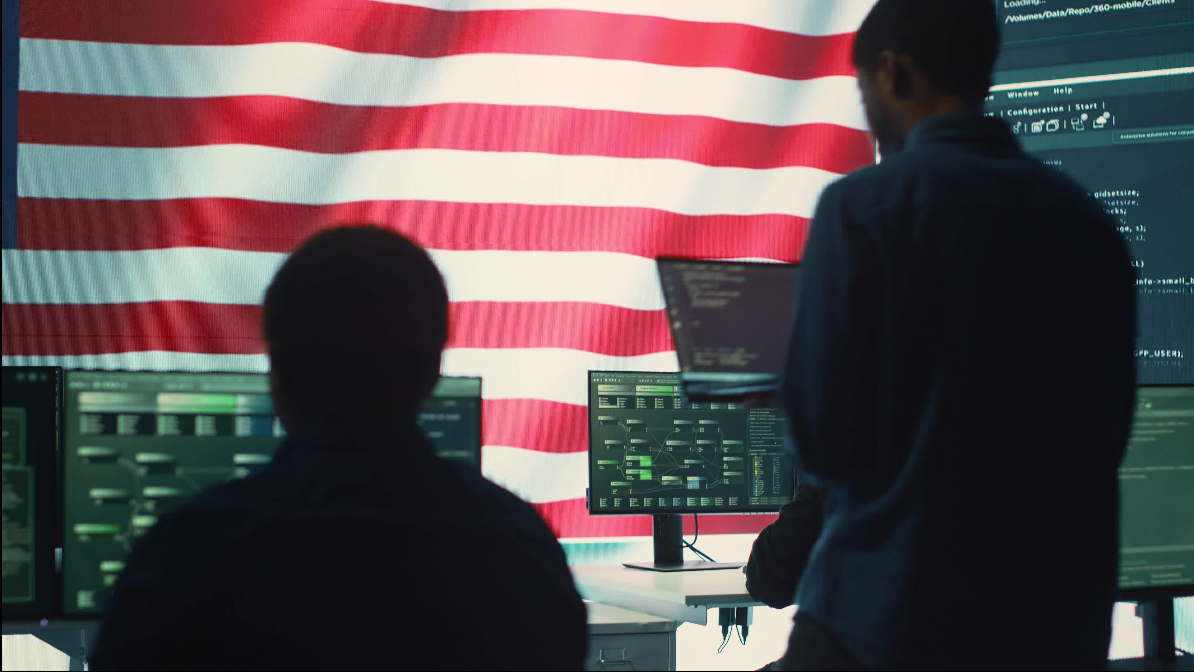 Cyber Defense Experts In A Governmental Tech Room With The American Flag Working On Secure