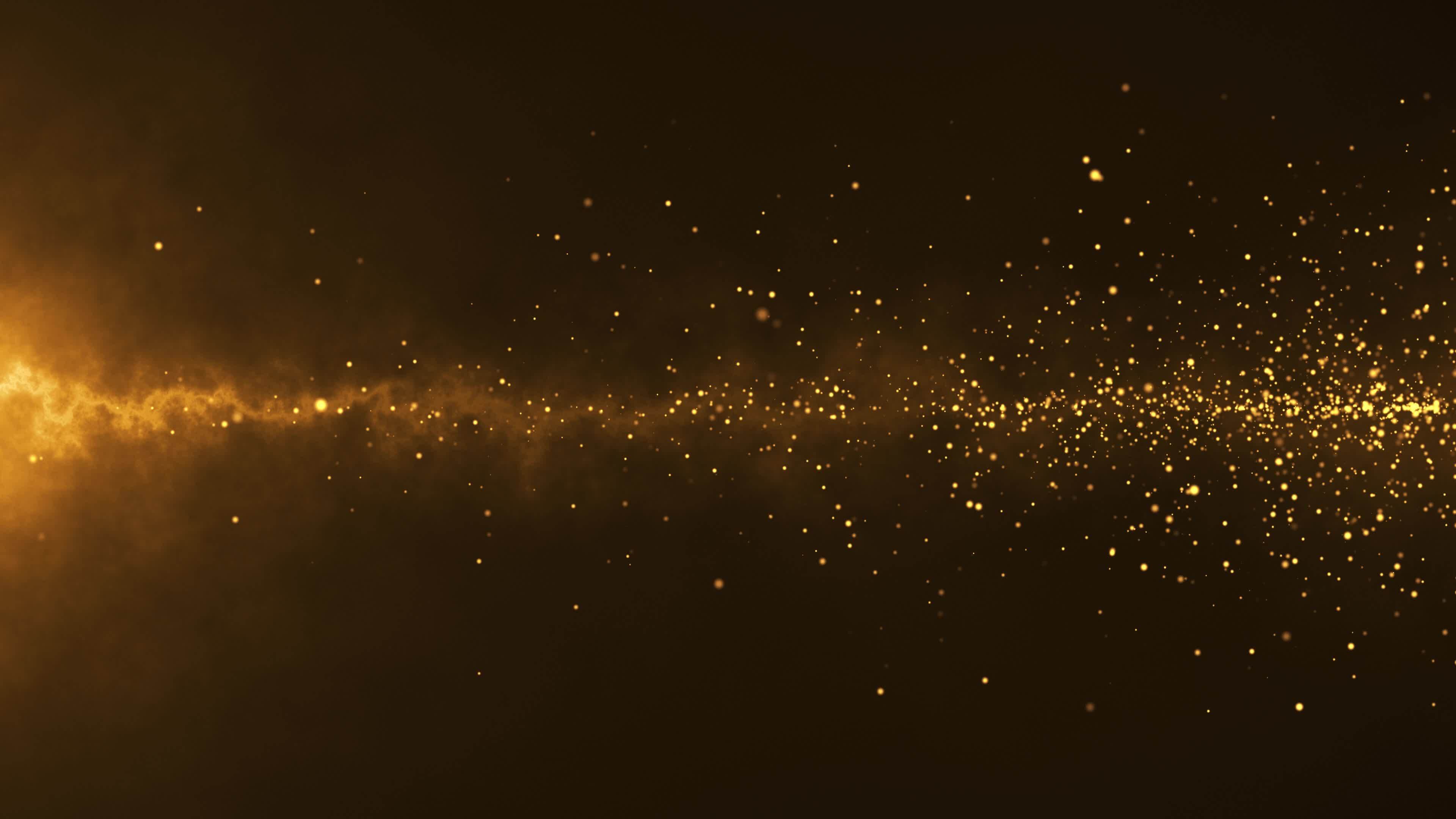 Movement of abstract particles of golden yellow sparkles sparkling in a ...