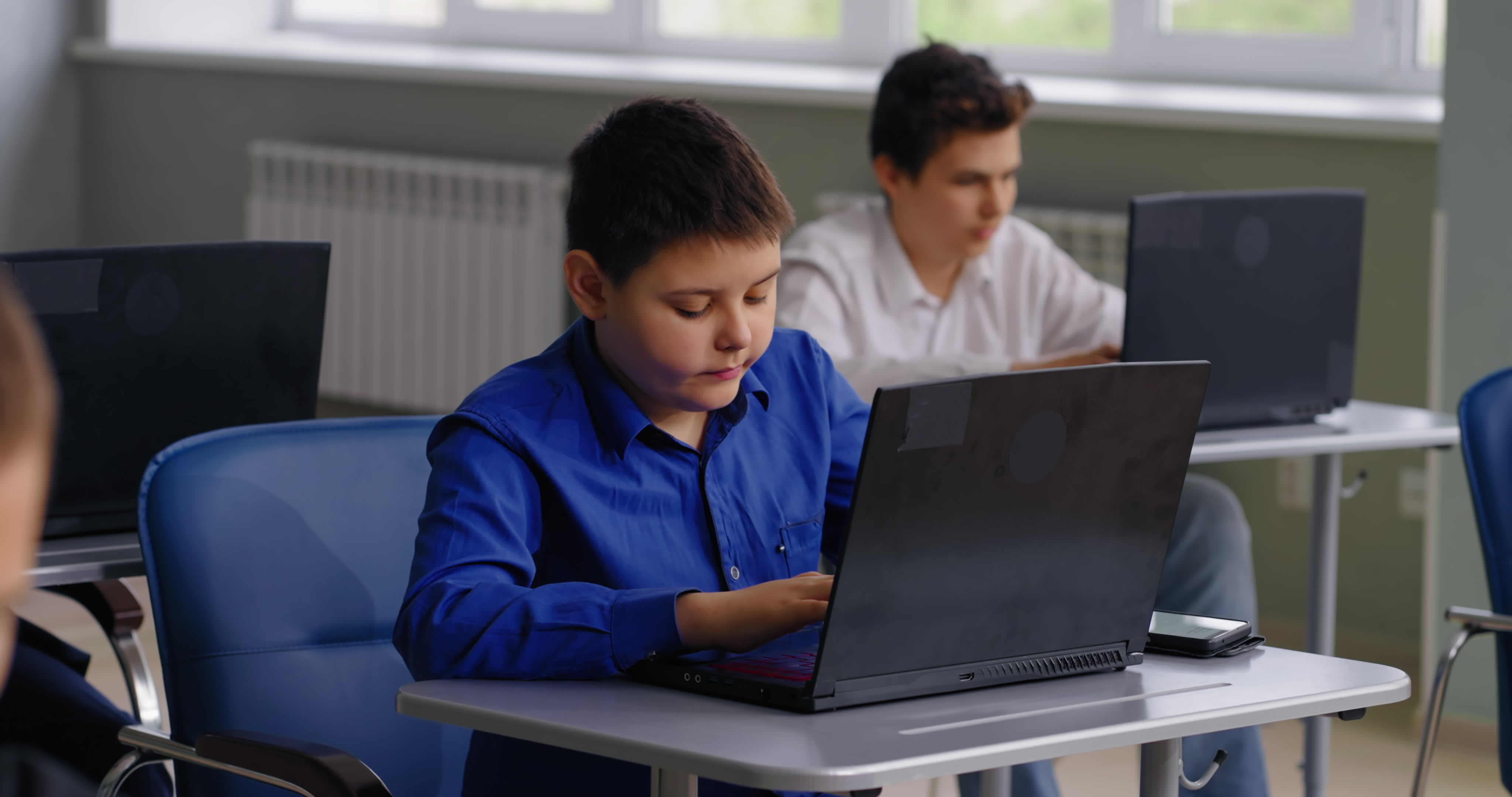 School Students Working With Laptops In Modern Computer-Based Classroom ...