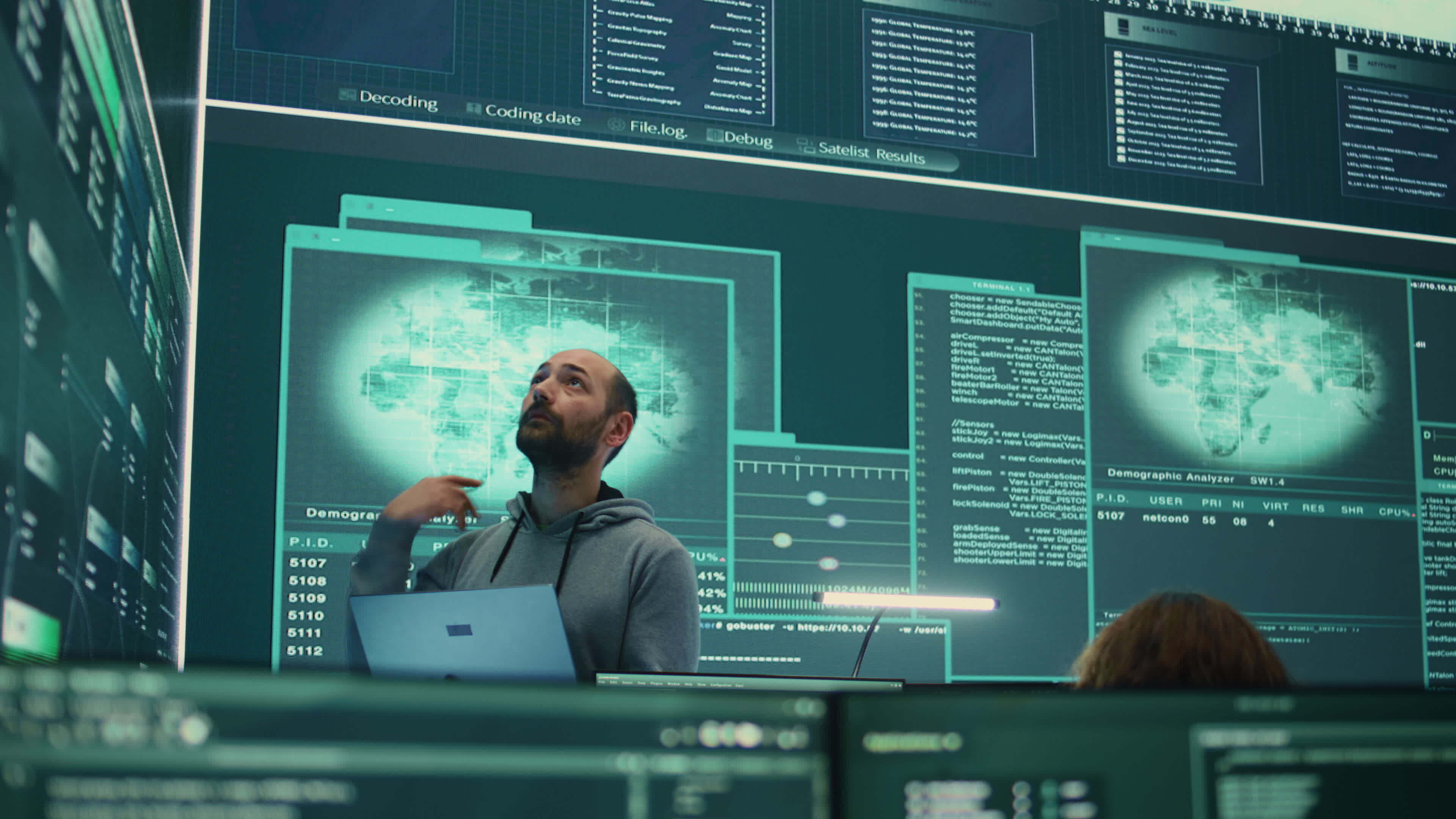 Governmental Hacker Examines Info On A Big Screen In Agency Office Using Advanced Technology To