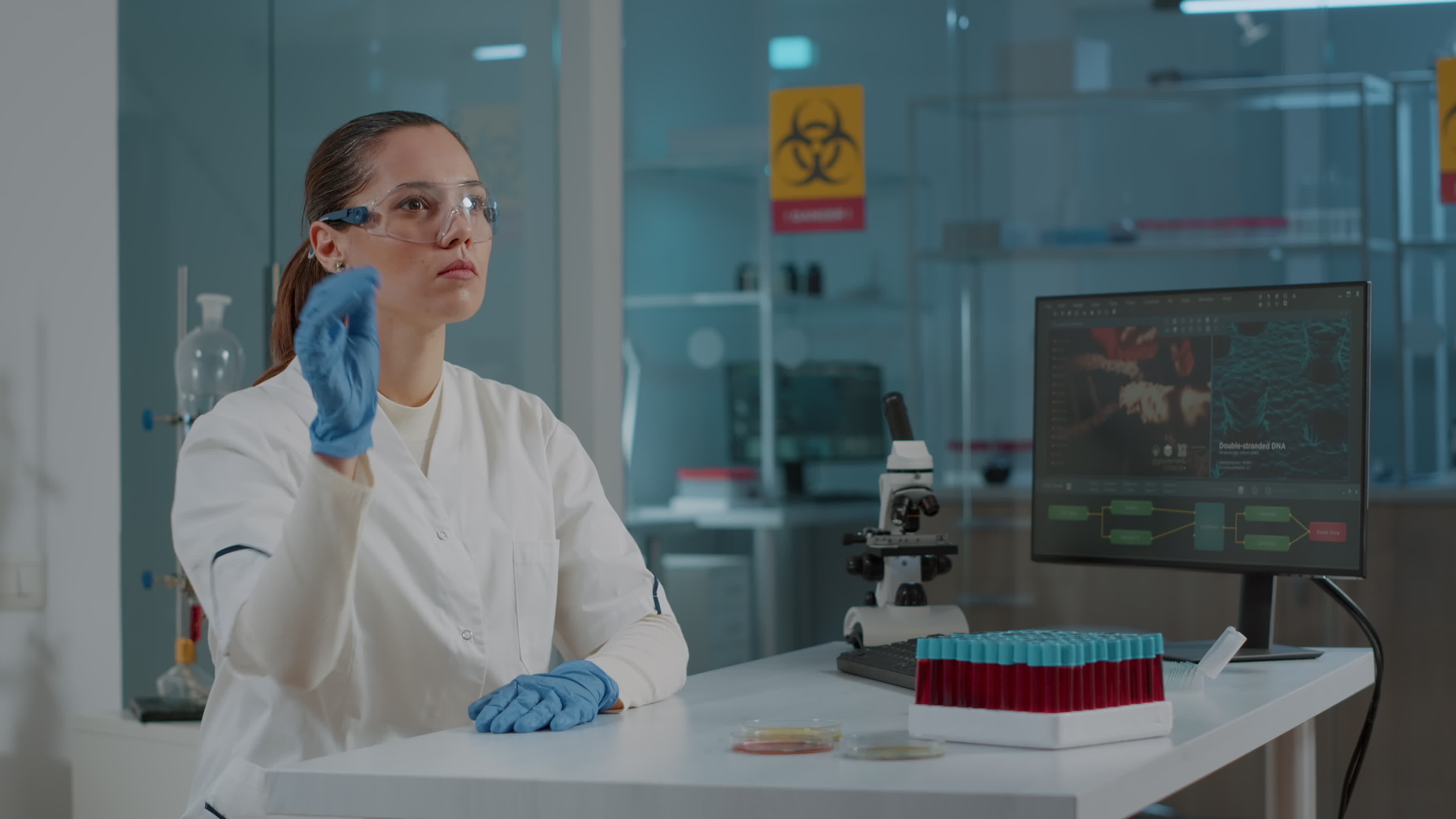 Lab worker using glasses with virtual reality to develop experiment, working with vr goggles to ...