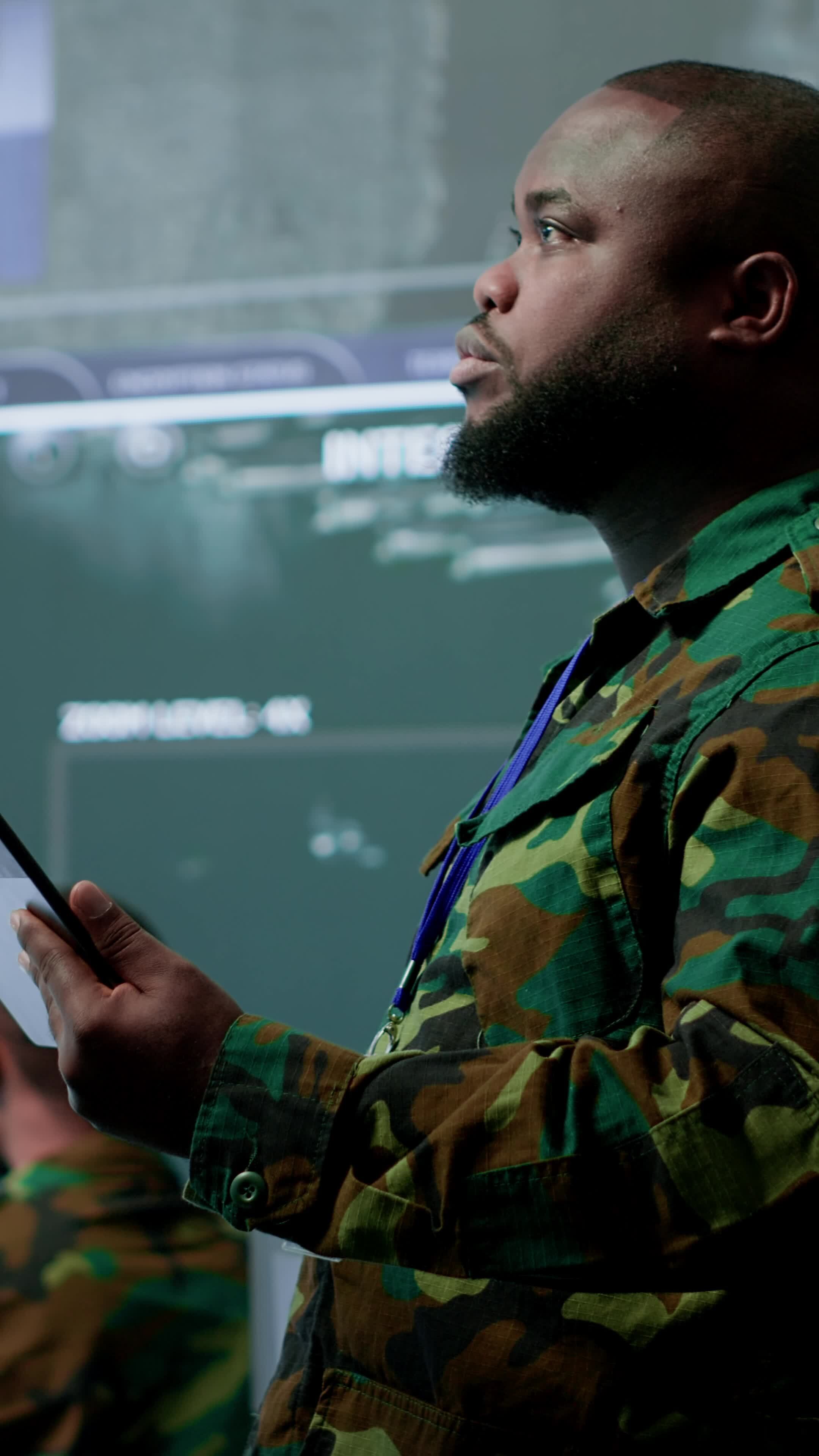 Vertical American Military Intelligence Officers In A Command Center Monitoring Surveillance