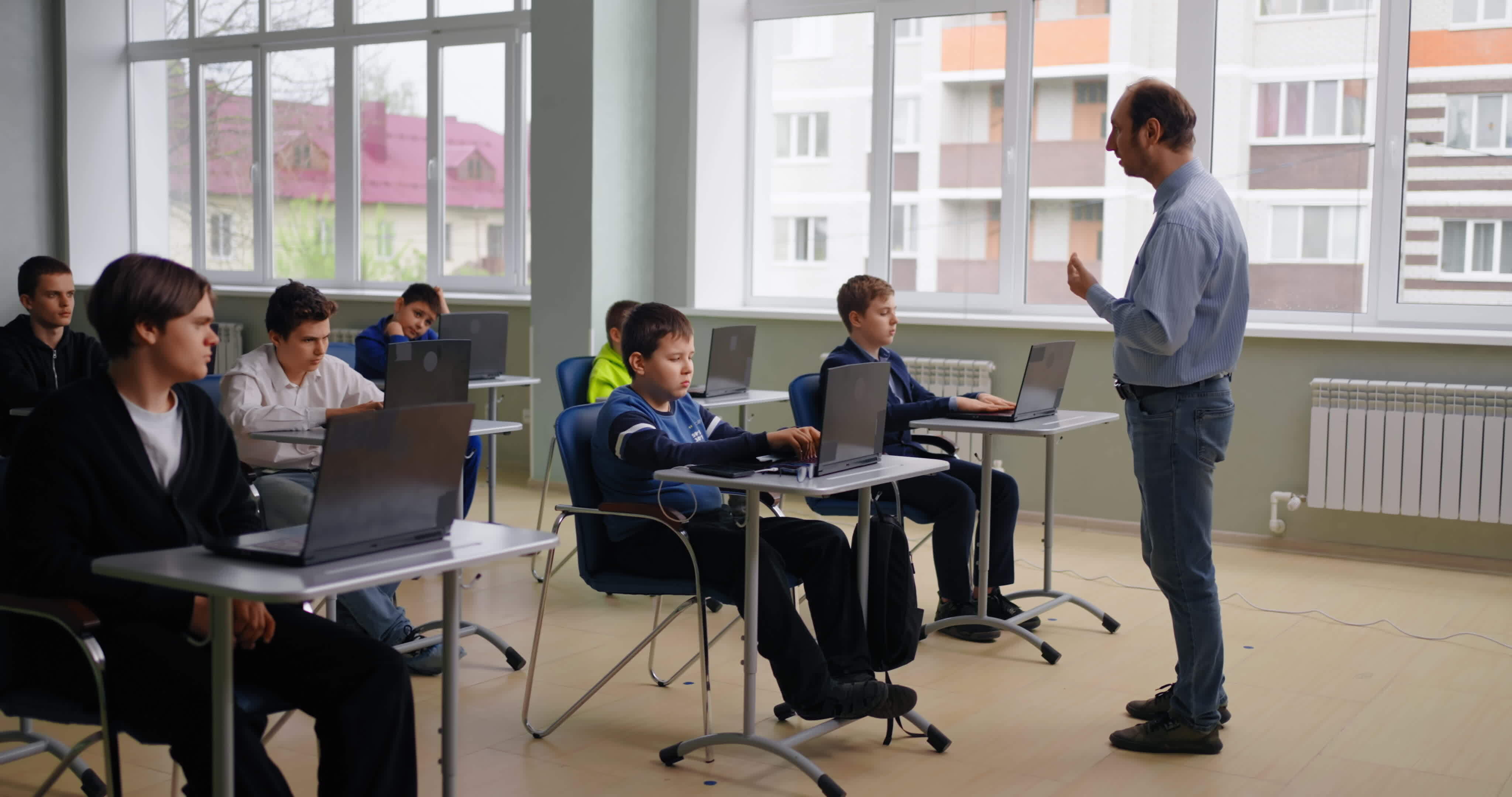 Teacher Speaking In Computer-Based Class, Diverse School Boys Learning In Coding Class, Smart ...