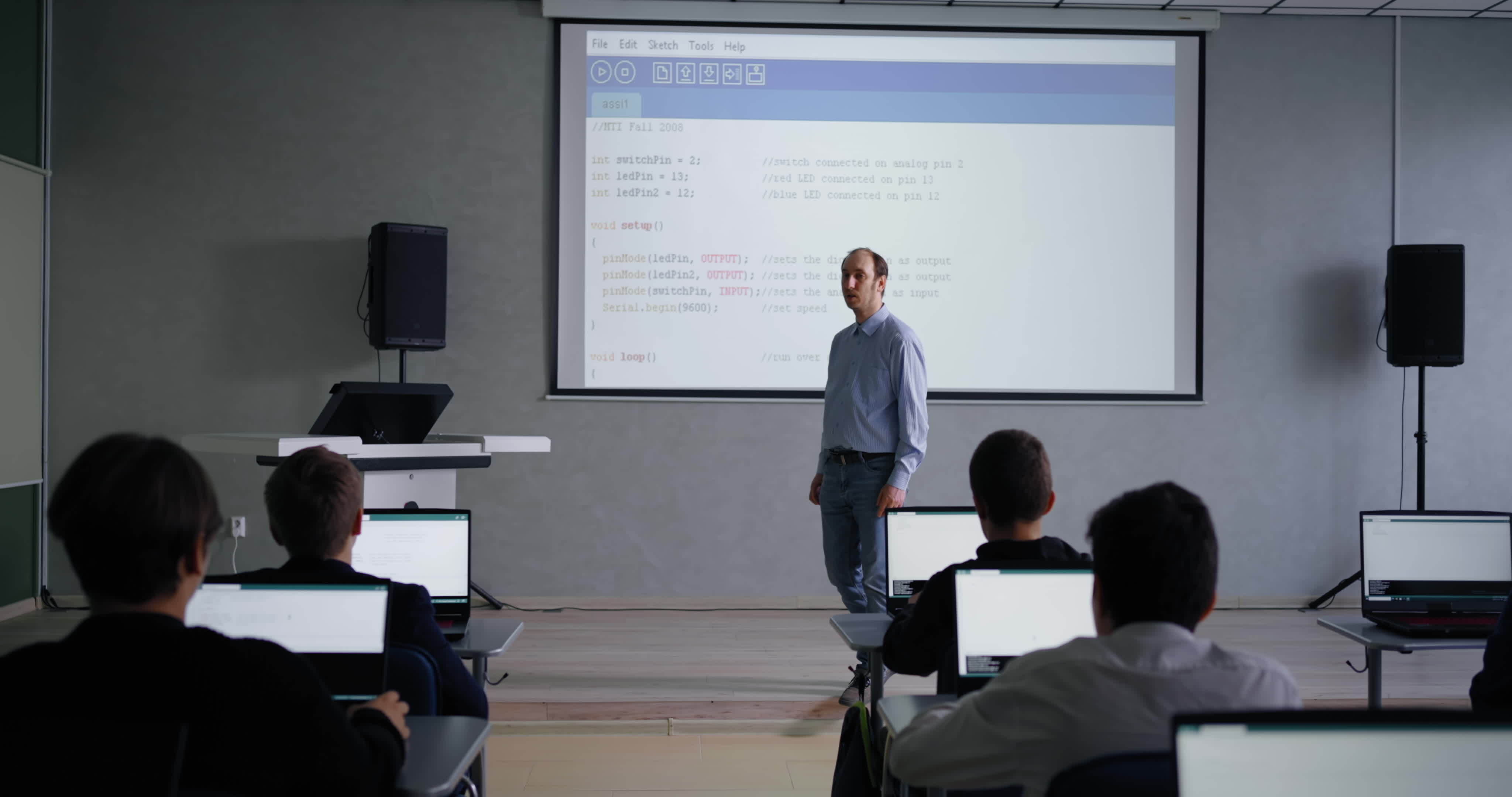 Middle-Aged Teacher Speaking In Classroom With School Students, Coding and Computer Science ...