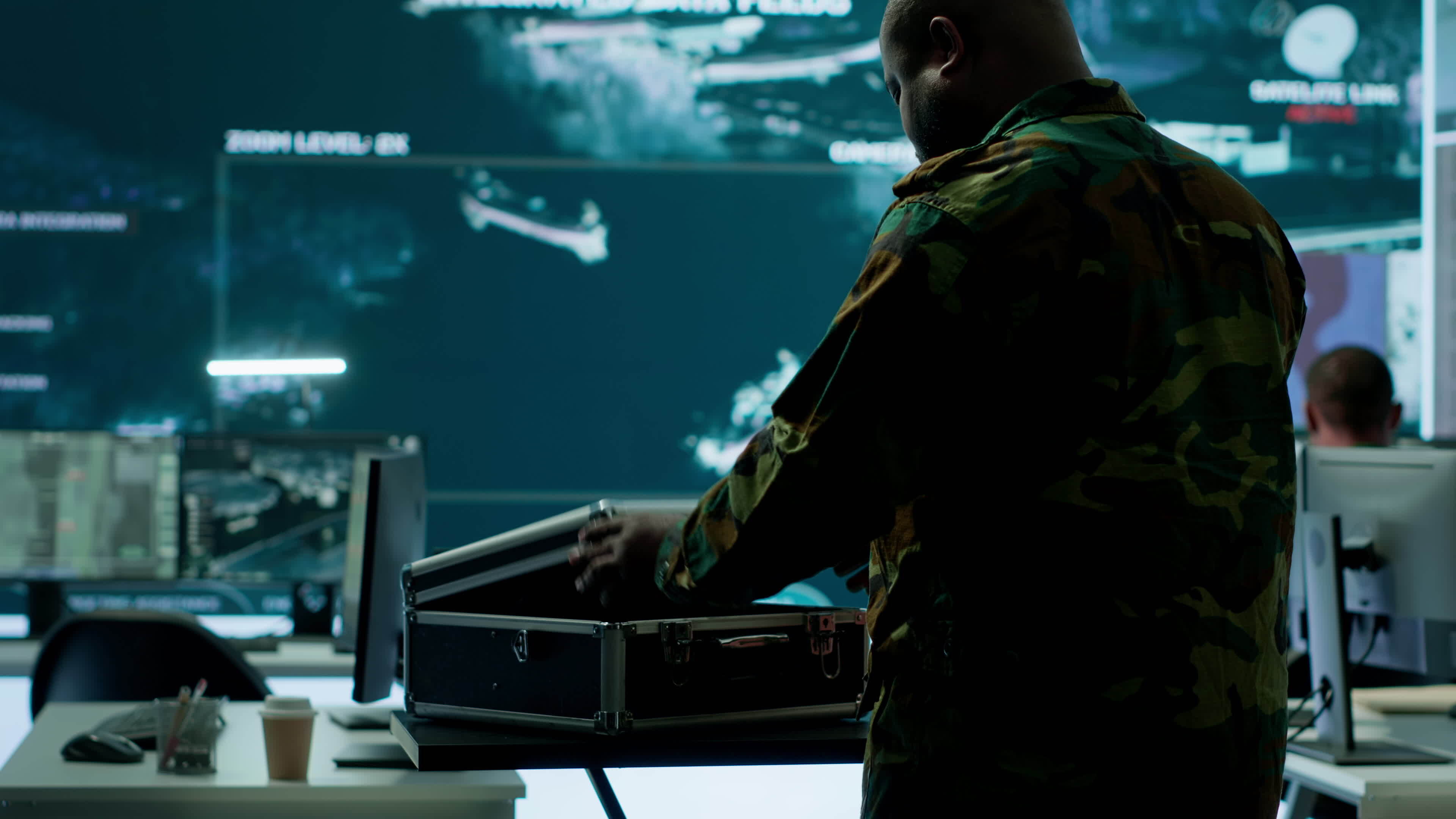 Army espionage specialist in a control center collecting satellite cctv data real time ...