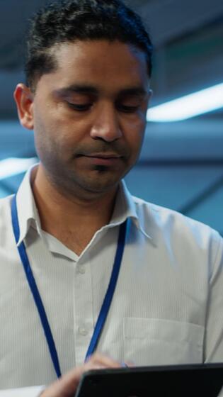 Vertical Engineer Walking In Data Center Monitoring Security Threats