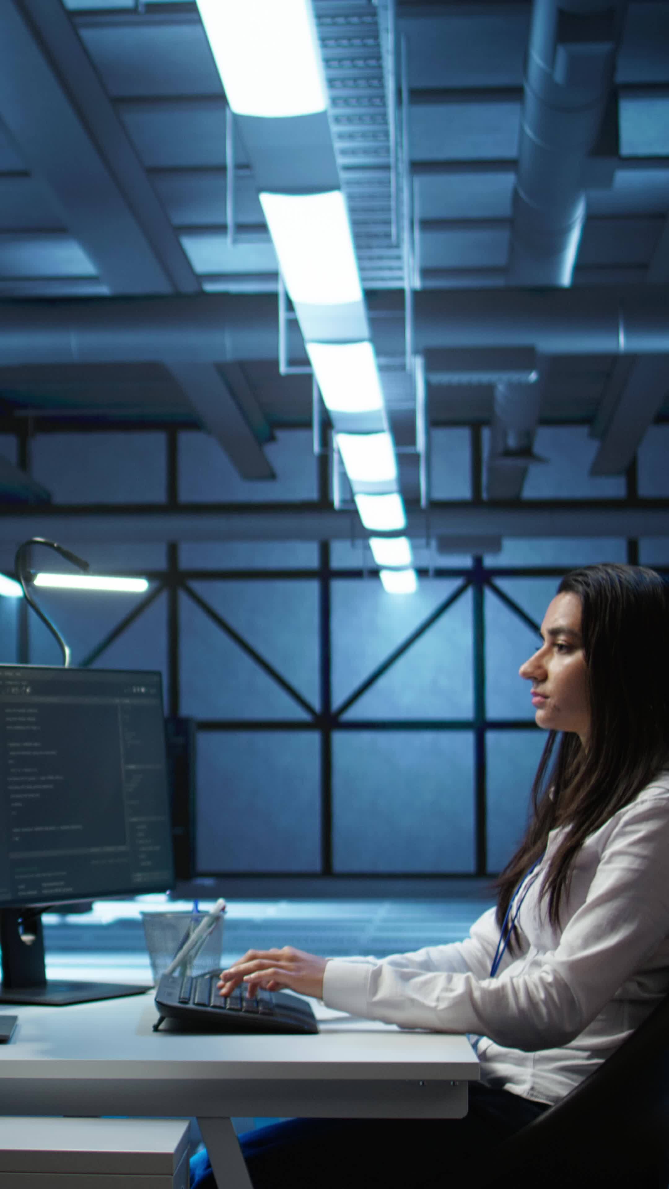 Vertical Teamworking colleagues in high tech data center managing and maintaining databases ...