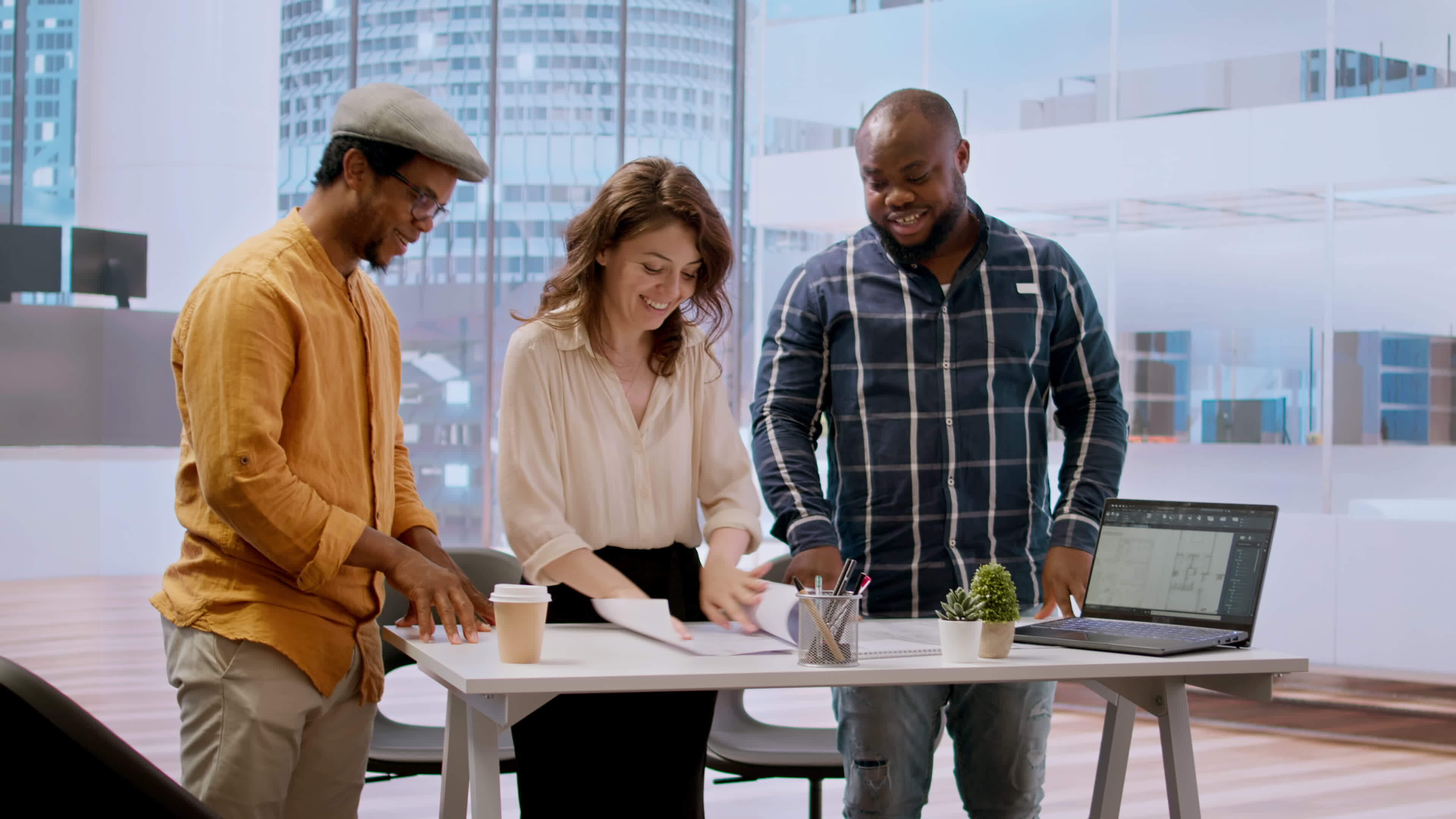 Professional Clients And Their Real Estate Agent Evaluating Blueprints