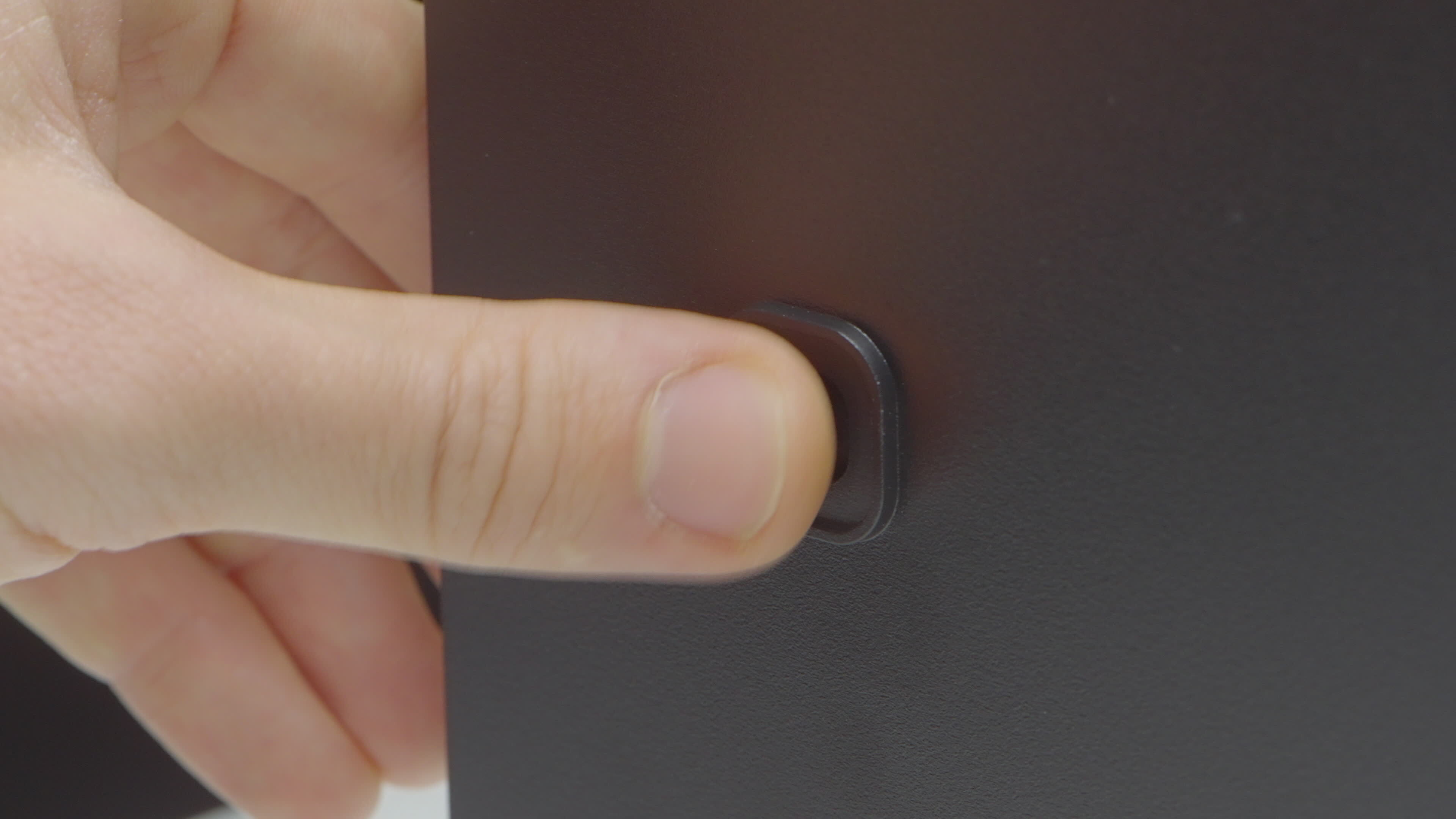 Close-up of pressing monitor start button. Action. Button for starting ...