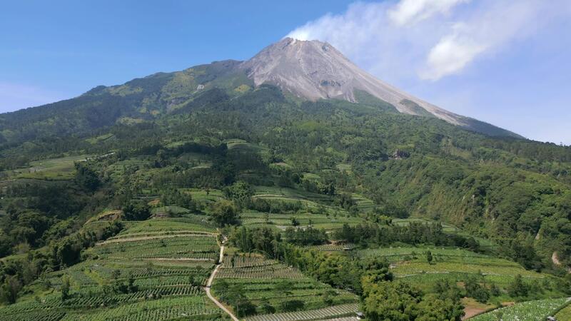 The active Merapi volcano and agricultural farmland on its slopes in ...