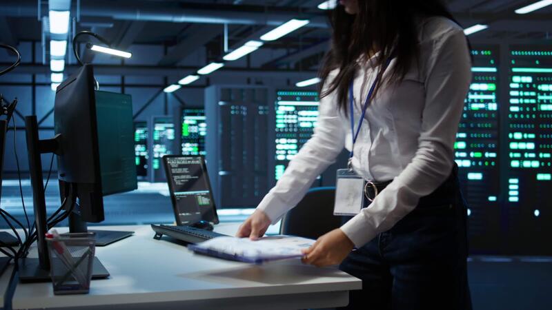 Engineer In Data Center Installing Software On Computer Helping Maintain Network