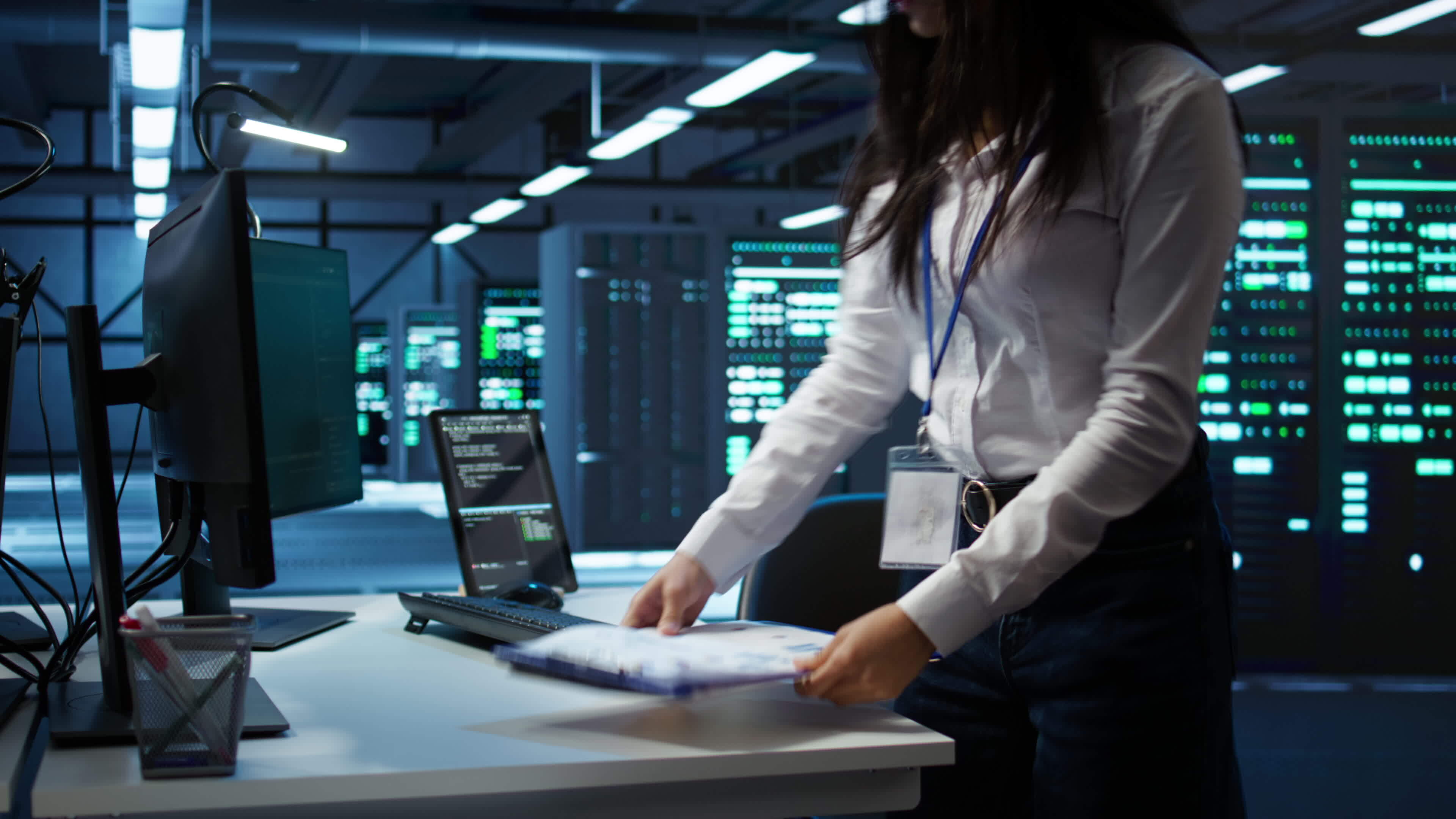 Engineer In Data Center Installing Software On Computer Helping