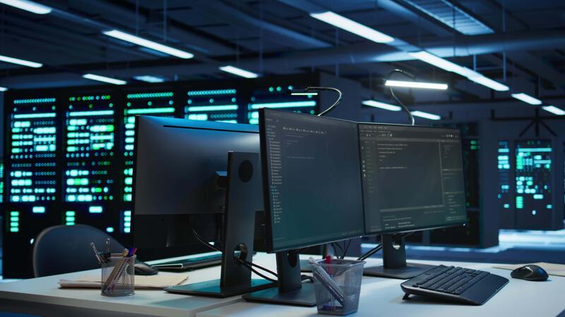 Multi Monitor Computer Setup In Data Center Used For Monitoring Security Threats Threatening