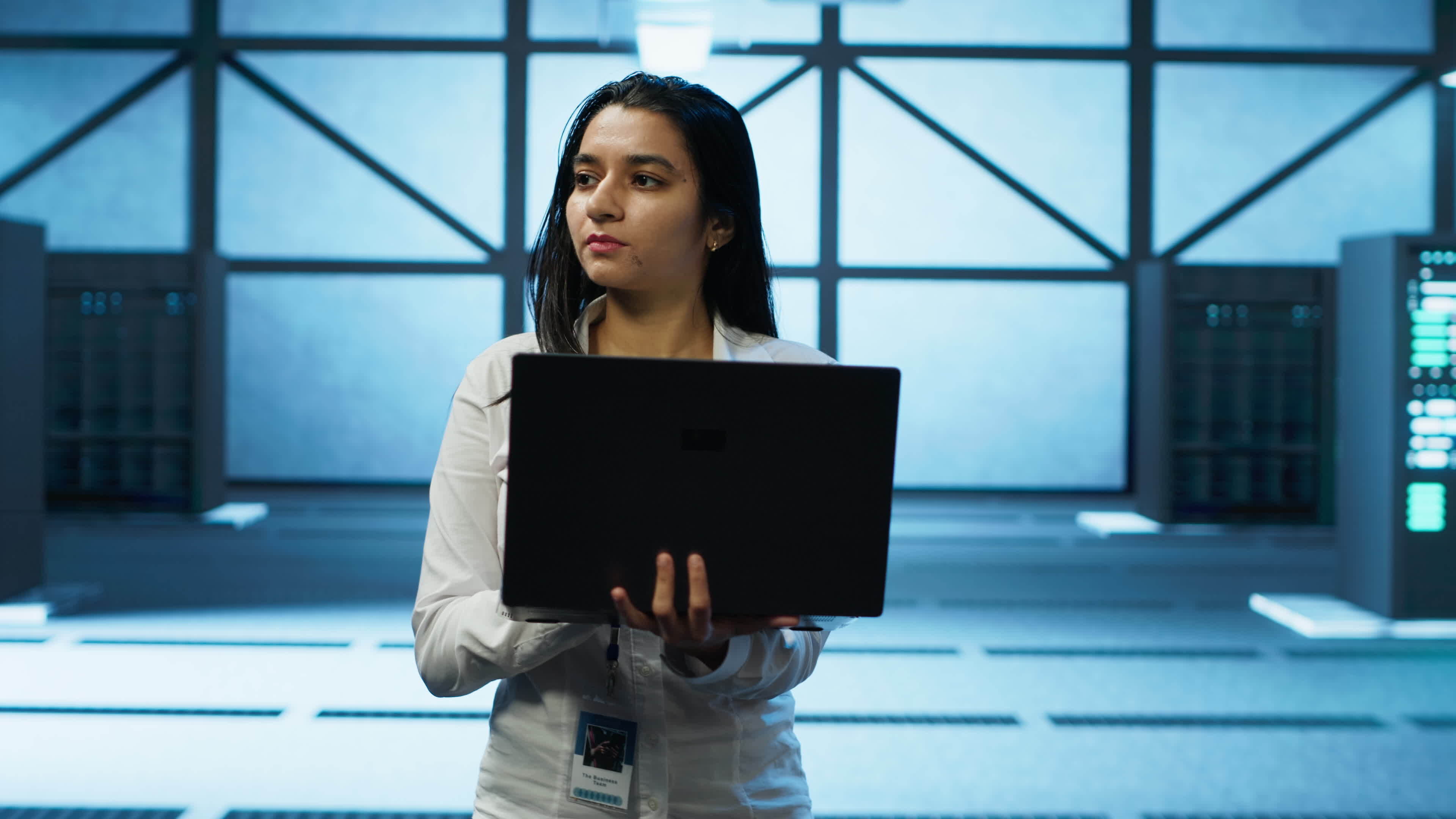 Programmer Walking In Data Center Using Notebook To Design Implement And Manage Gear Ensuring