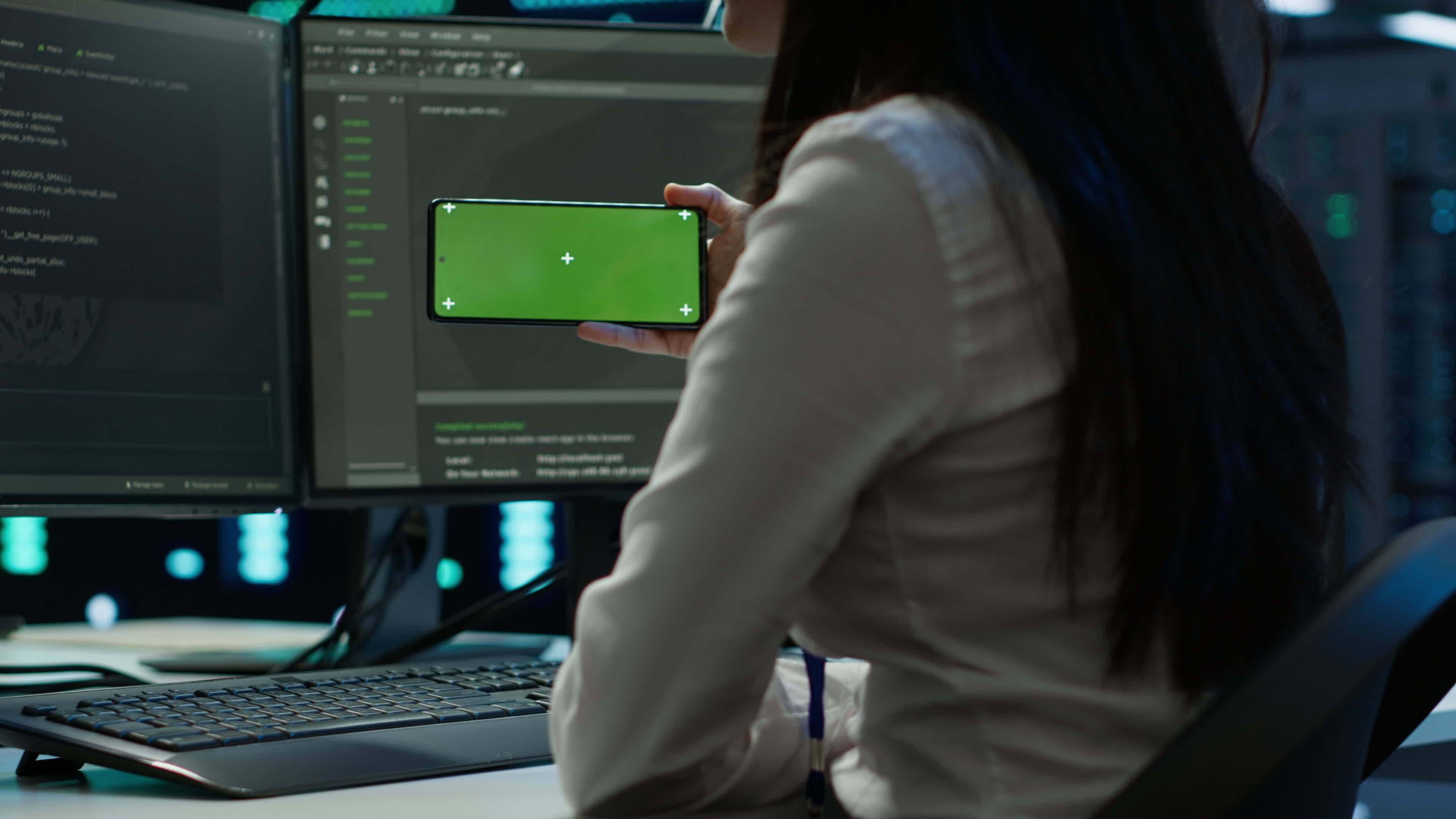 Zoom in on green screen mobile phone used by data center employee ... Zoom in on green screen mobile phone used by data center employee ...
