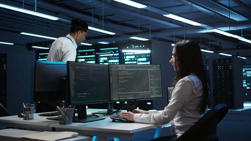 Computer scientists in data center managing and maintaining databases, ensuring data integrity ...