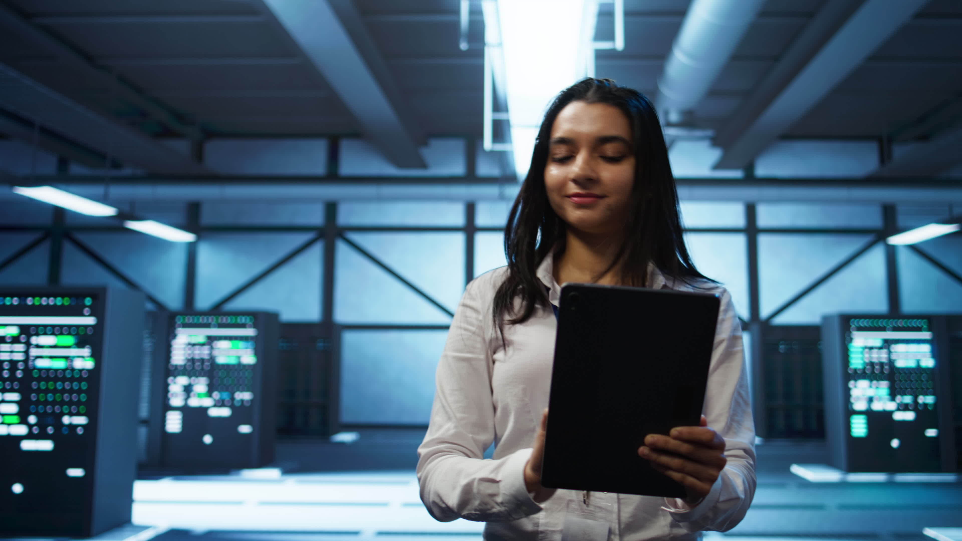 Admin In Data Center Monitoring Security Threats With Tablet